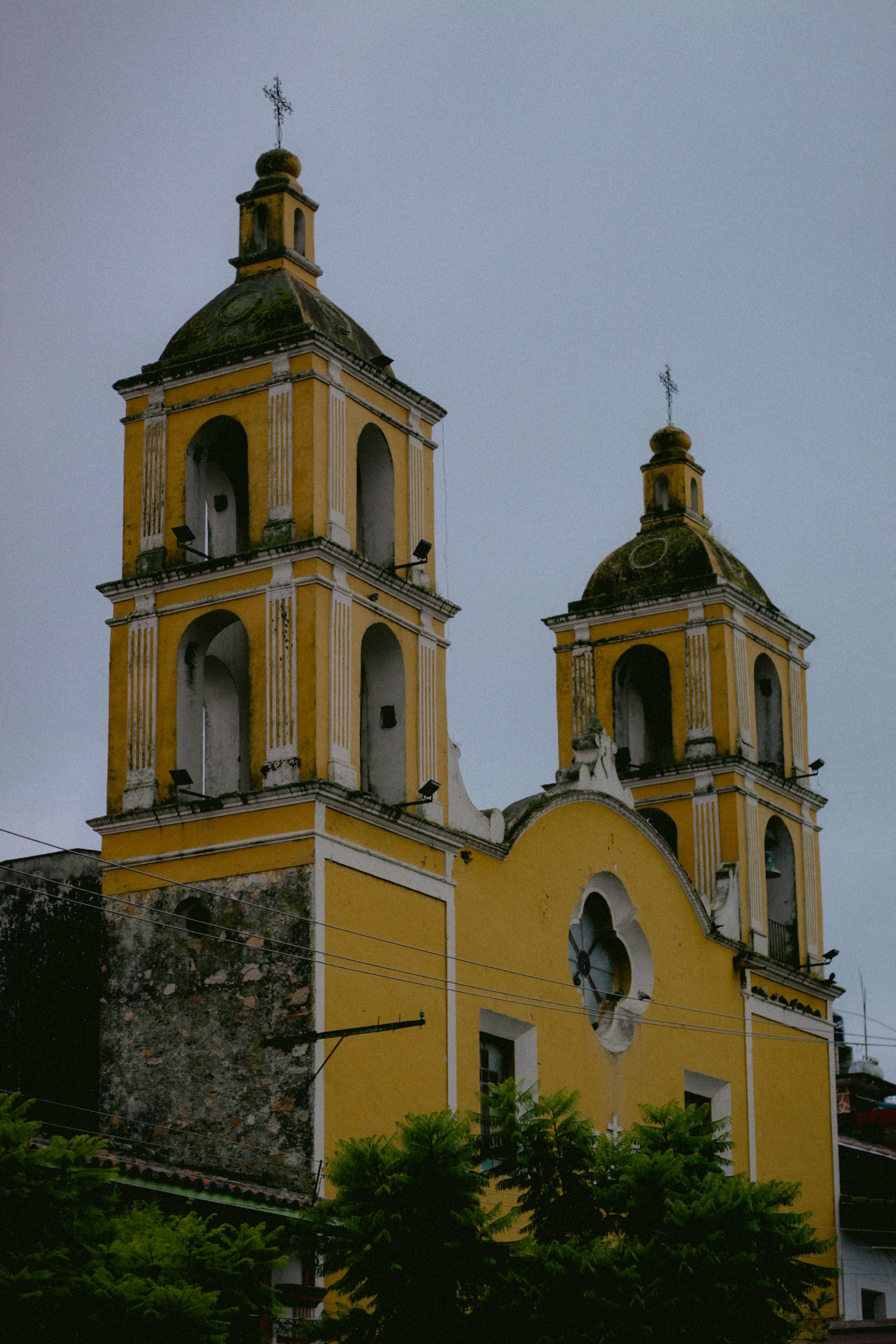 Historic Yellow Church with Twin Bell Towers and Crosses · Free Stock Photo