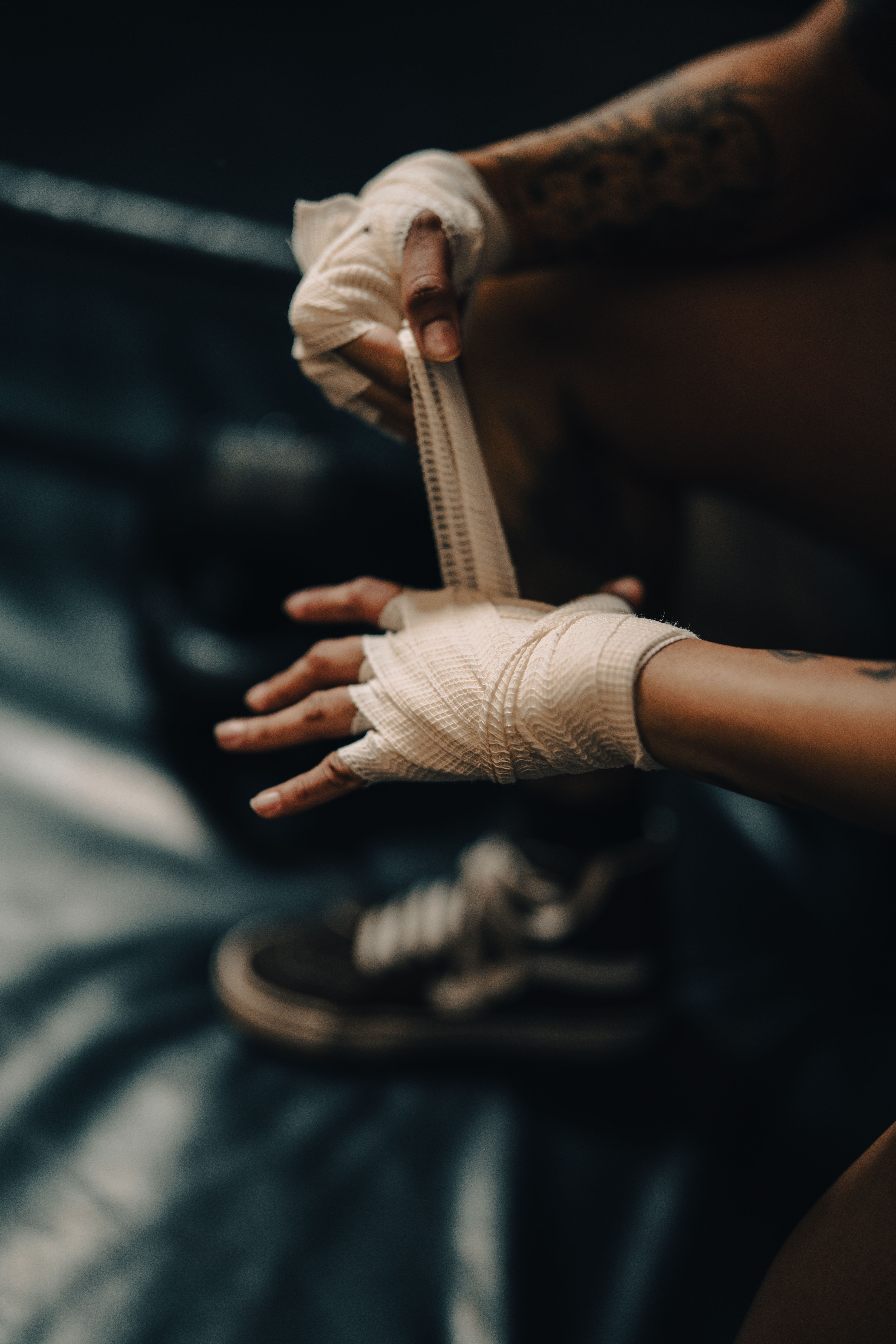 Boxer Wrapping Hands with Bandages in Gym · Free Stock Photo