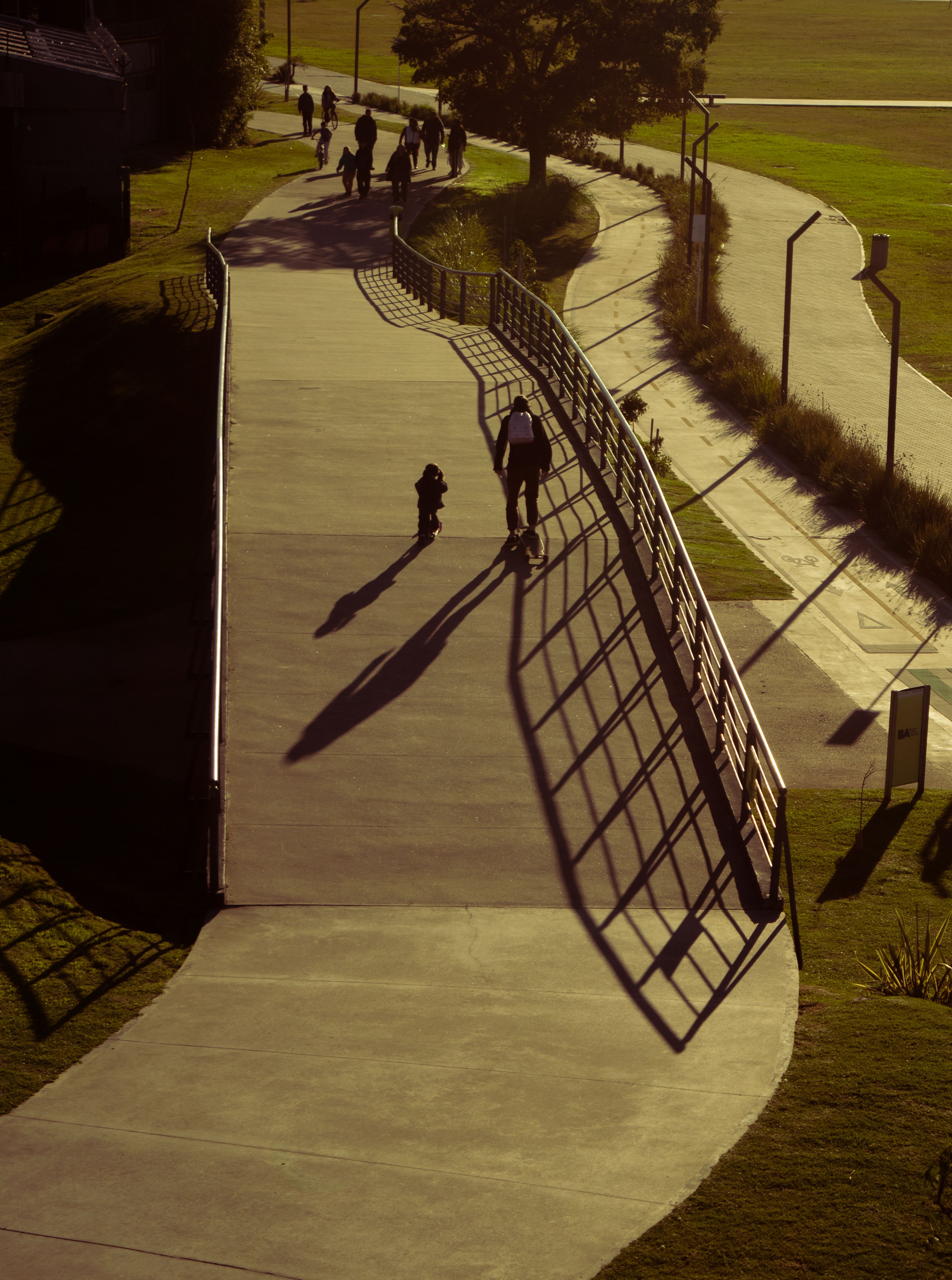 Evening Stroll on Urban Walkway with Long Shadows · Free Stock Photo