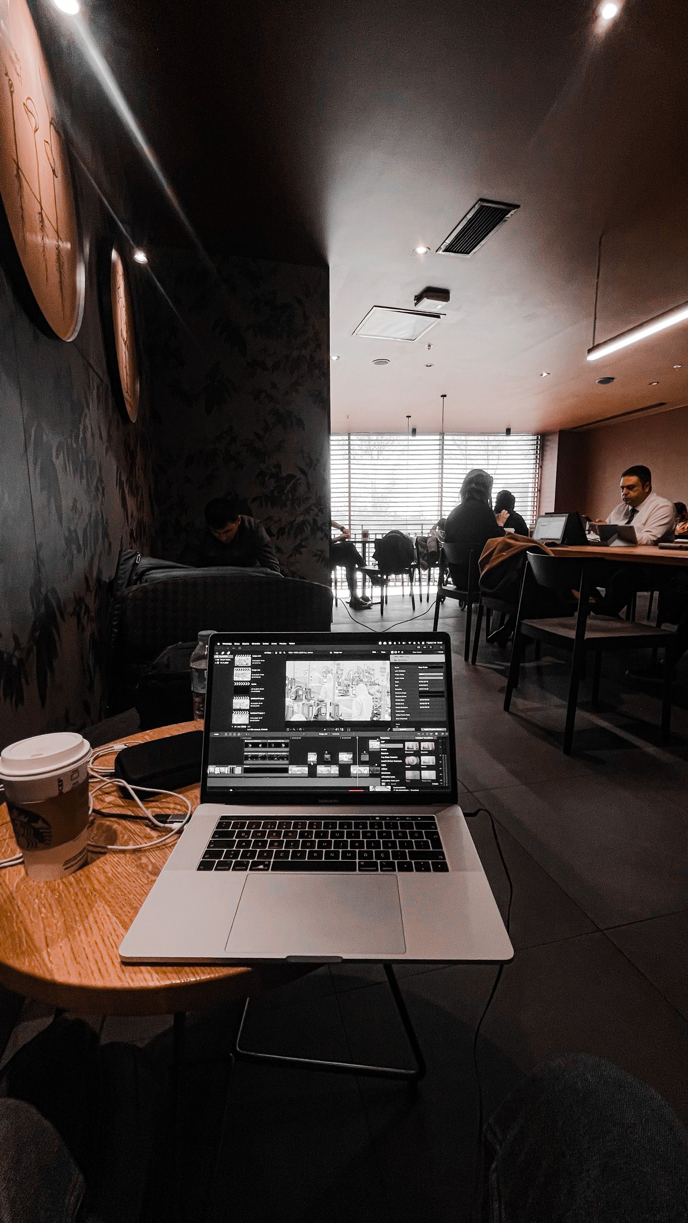 Cozy Coffee Shop Workspace with Laptop and Coffee · Free Stock Photo