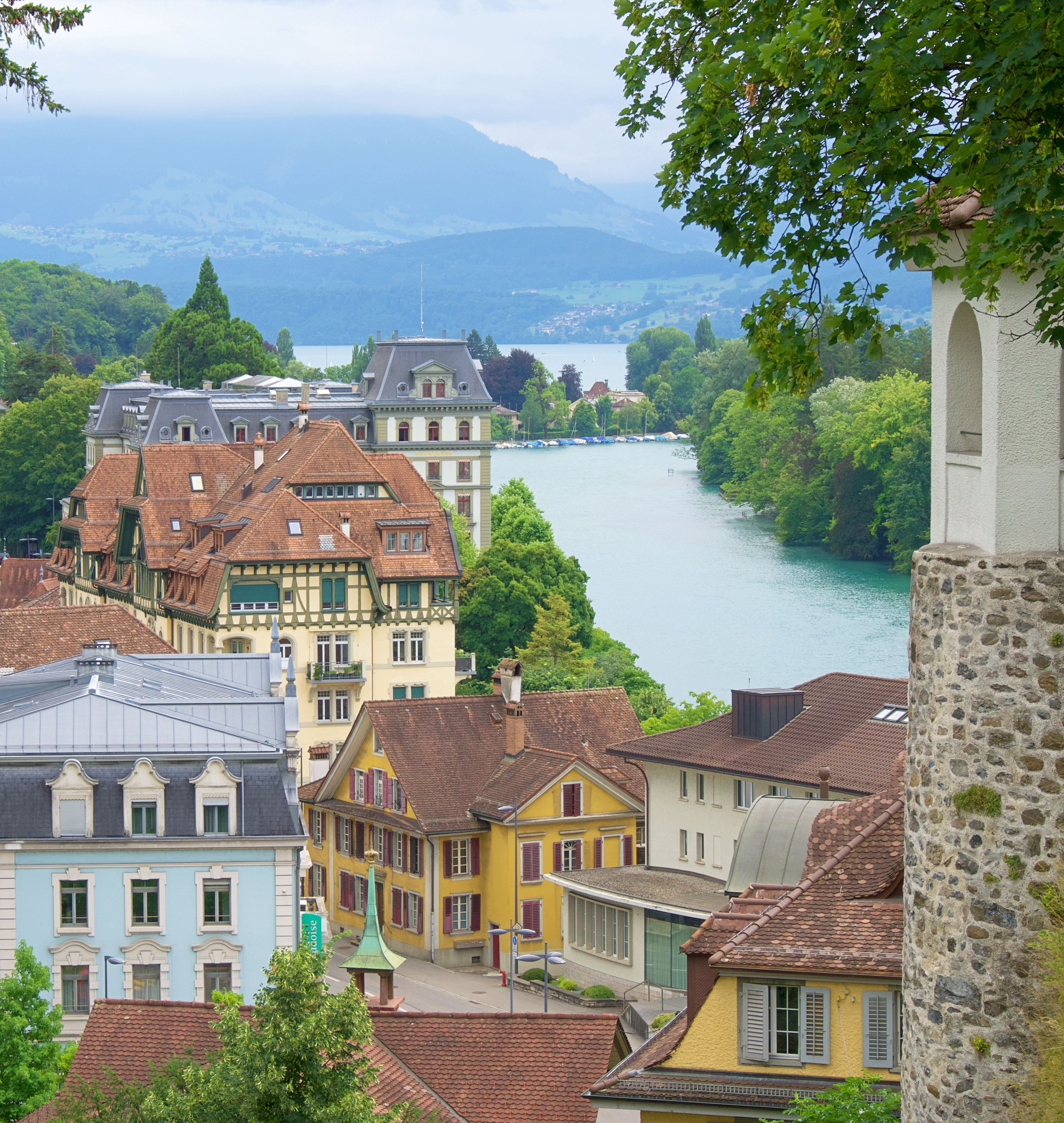 Charming Swiss Village Overlooking River and Mountains · Free Stock Photo