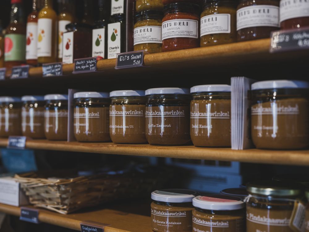 Artisanal Food Products on Wooden Shelves · Free Stock Photo