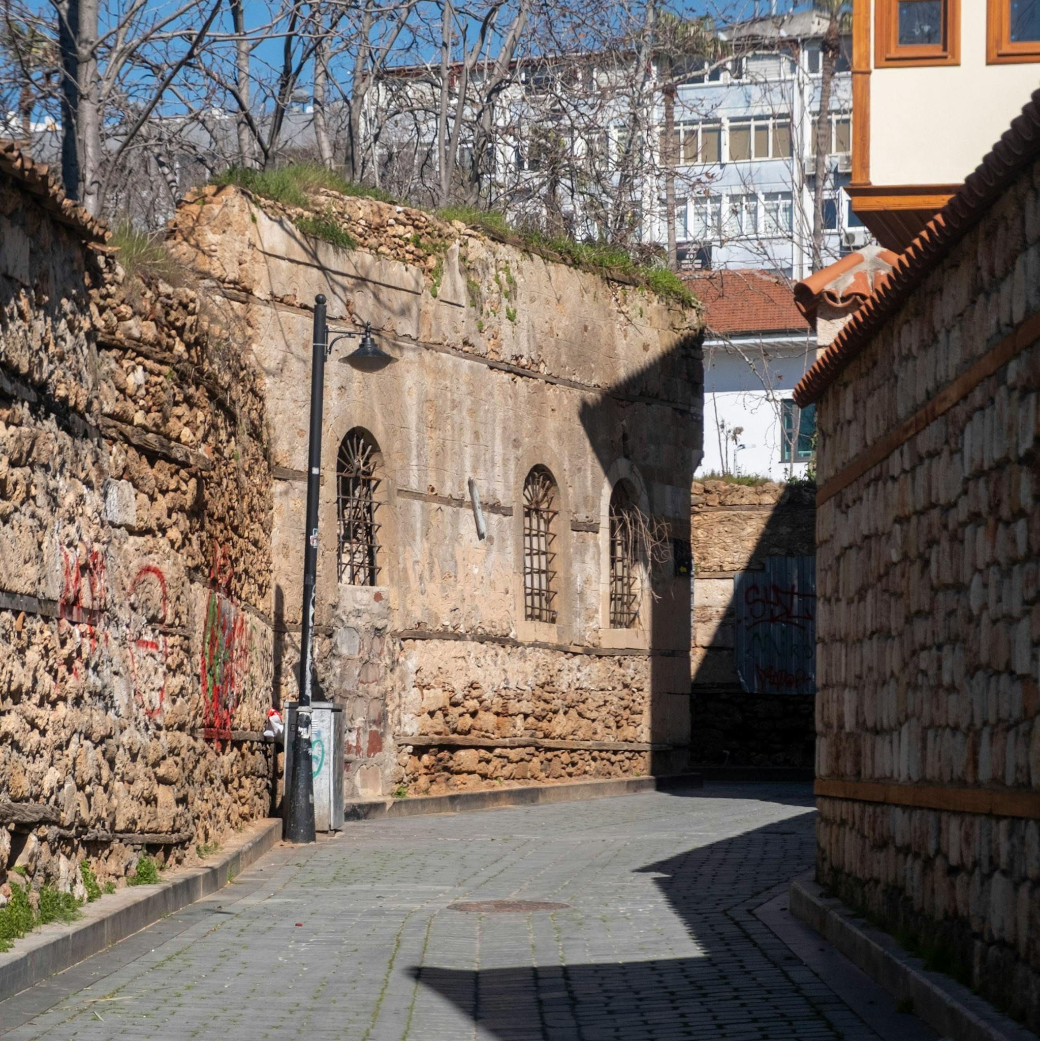 Historic Narrow Stone Alleyway with Sunlight · Free Stock Photo