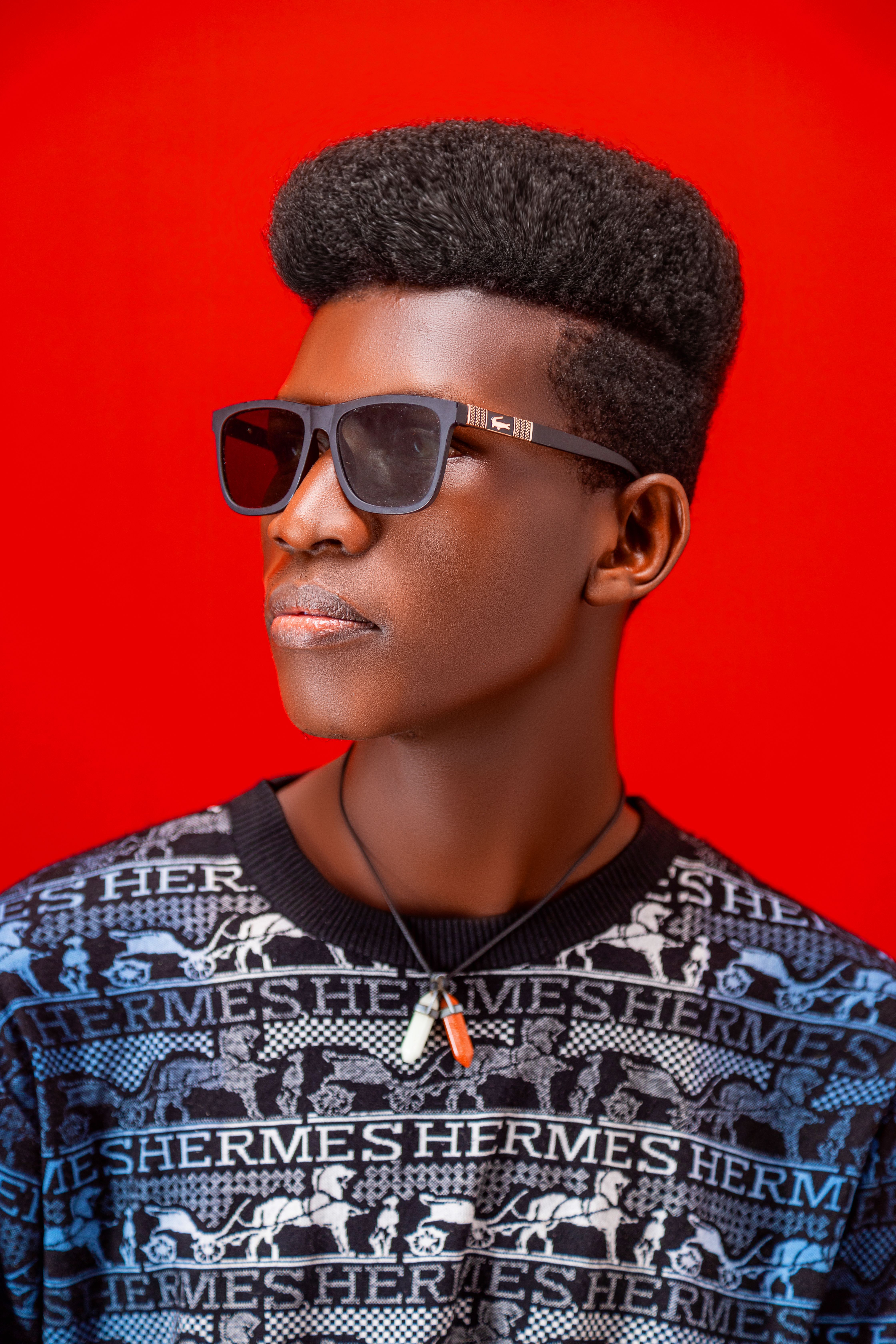 Stylish Young Man in Sunglasses Against Red · Free Stock Photo