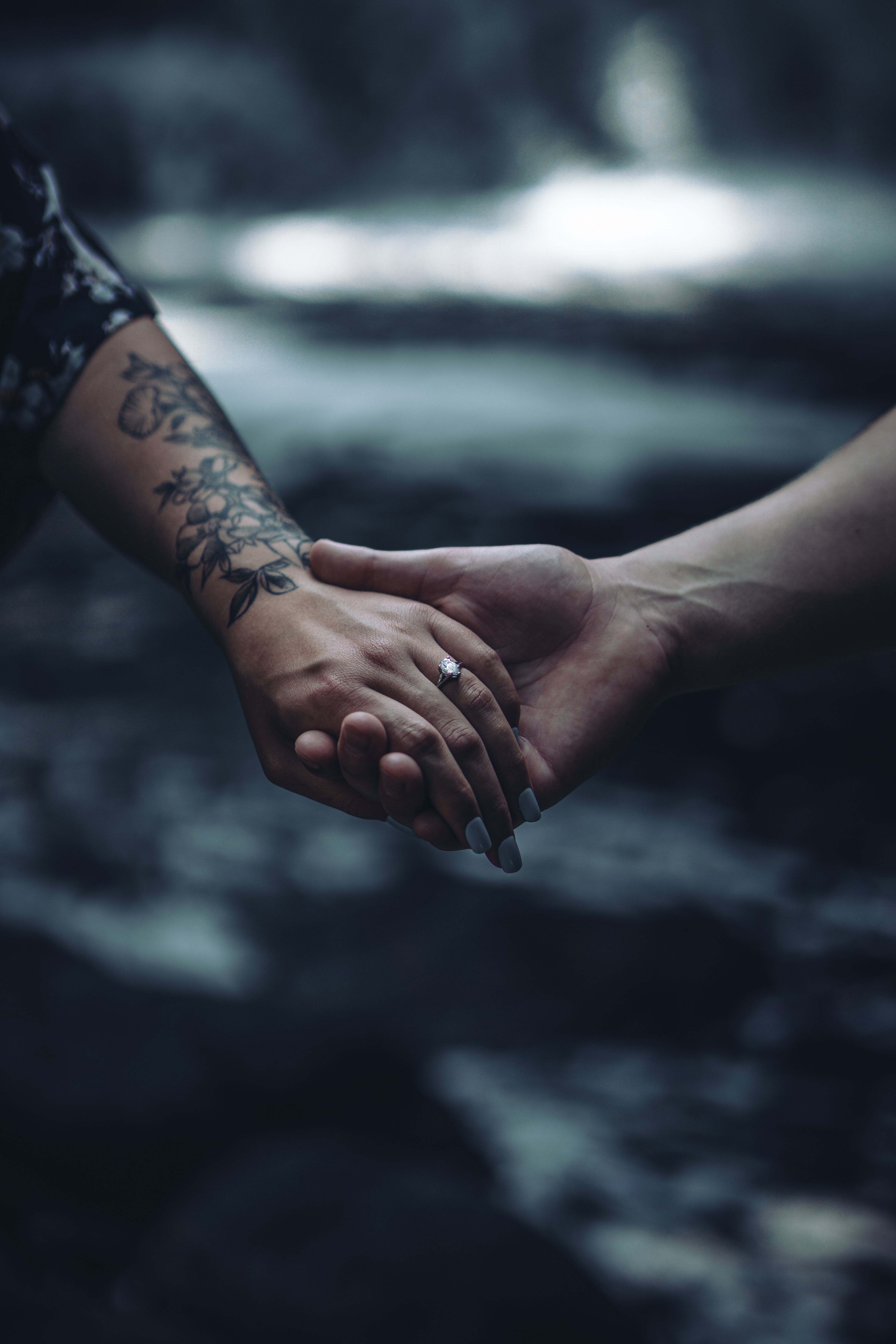 Romantic Close-Up of a Couple Holding Hands Outdoors · Free Stock Photo