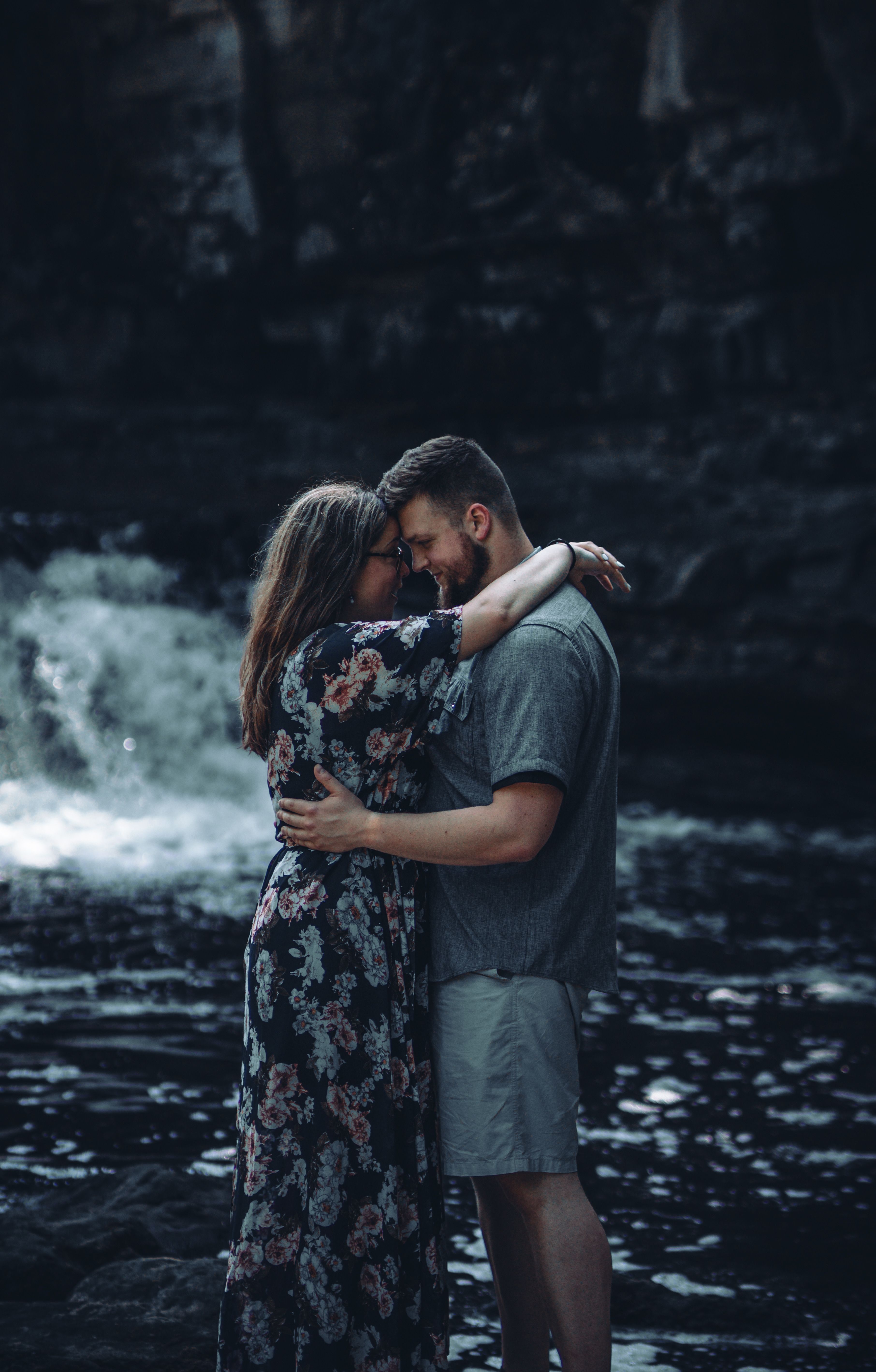 Romantic Couple Embracing Near Waterfall · Free Stock Photo