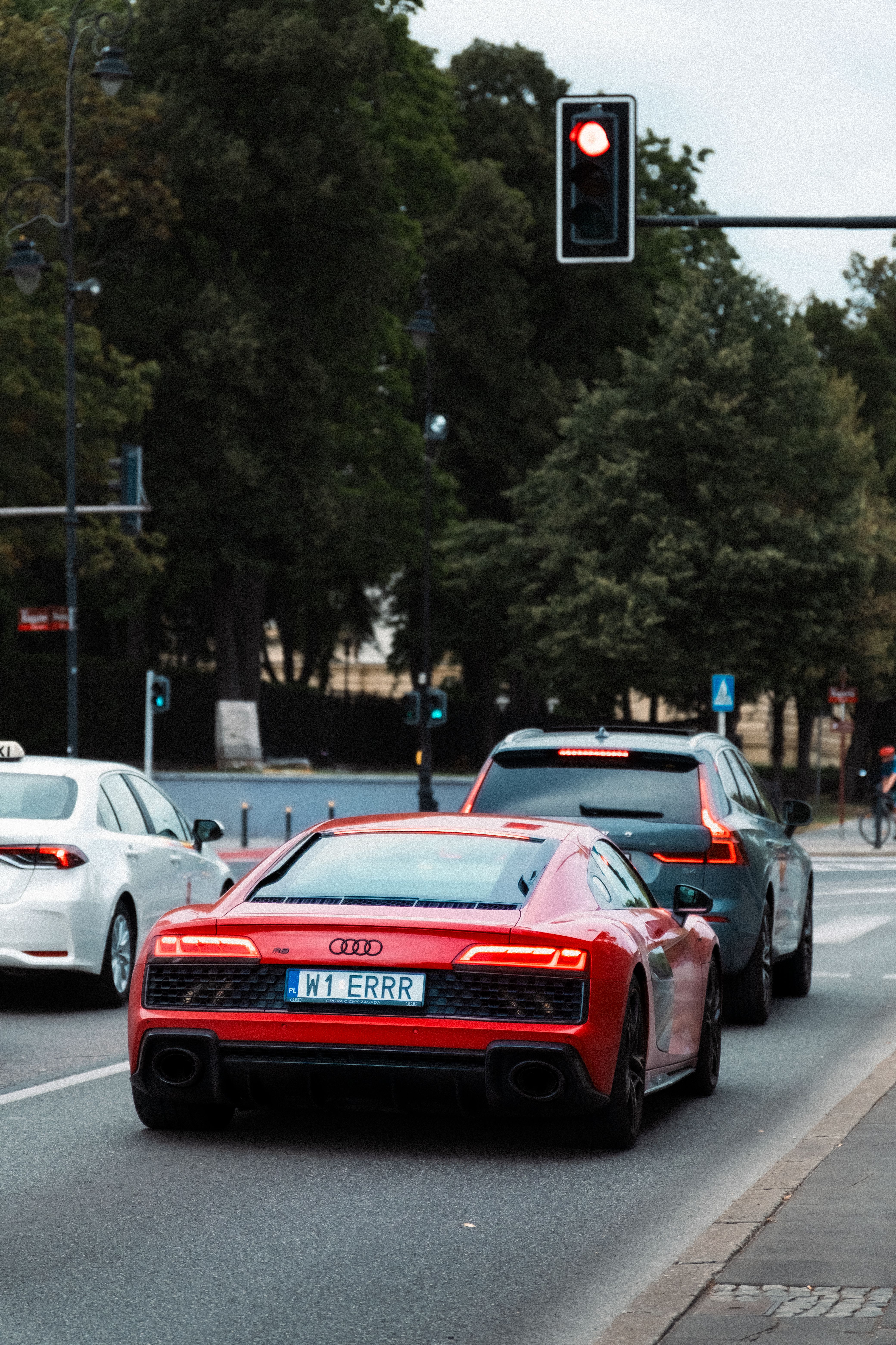 Red Sports Car at Urban Intersection Traffic Light · Free Stock Photo