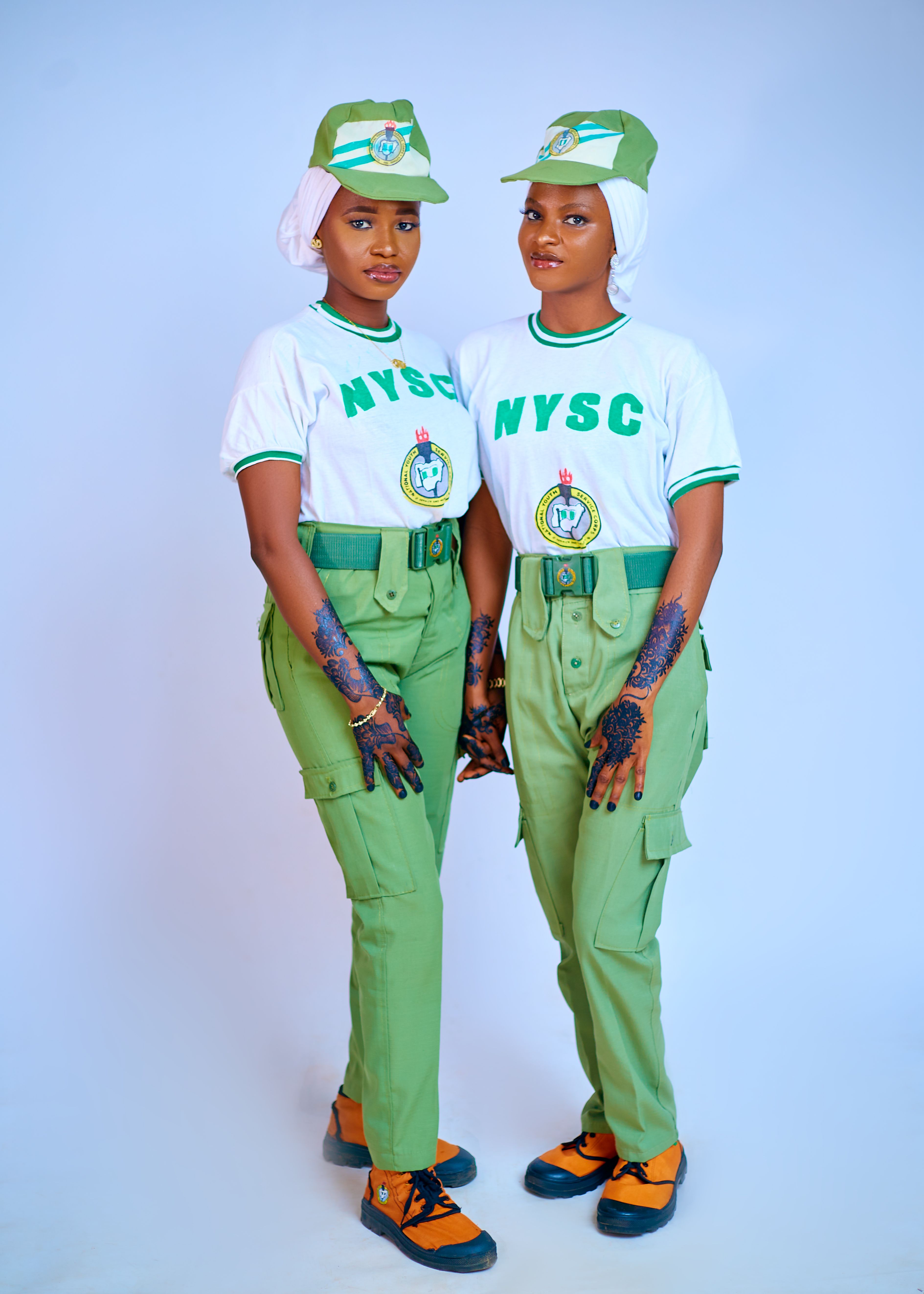 Two Women in NYSC Uniforms Posing Together · Free Stock Photo