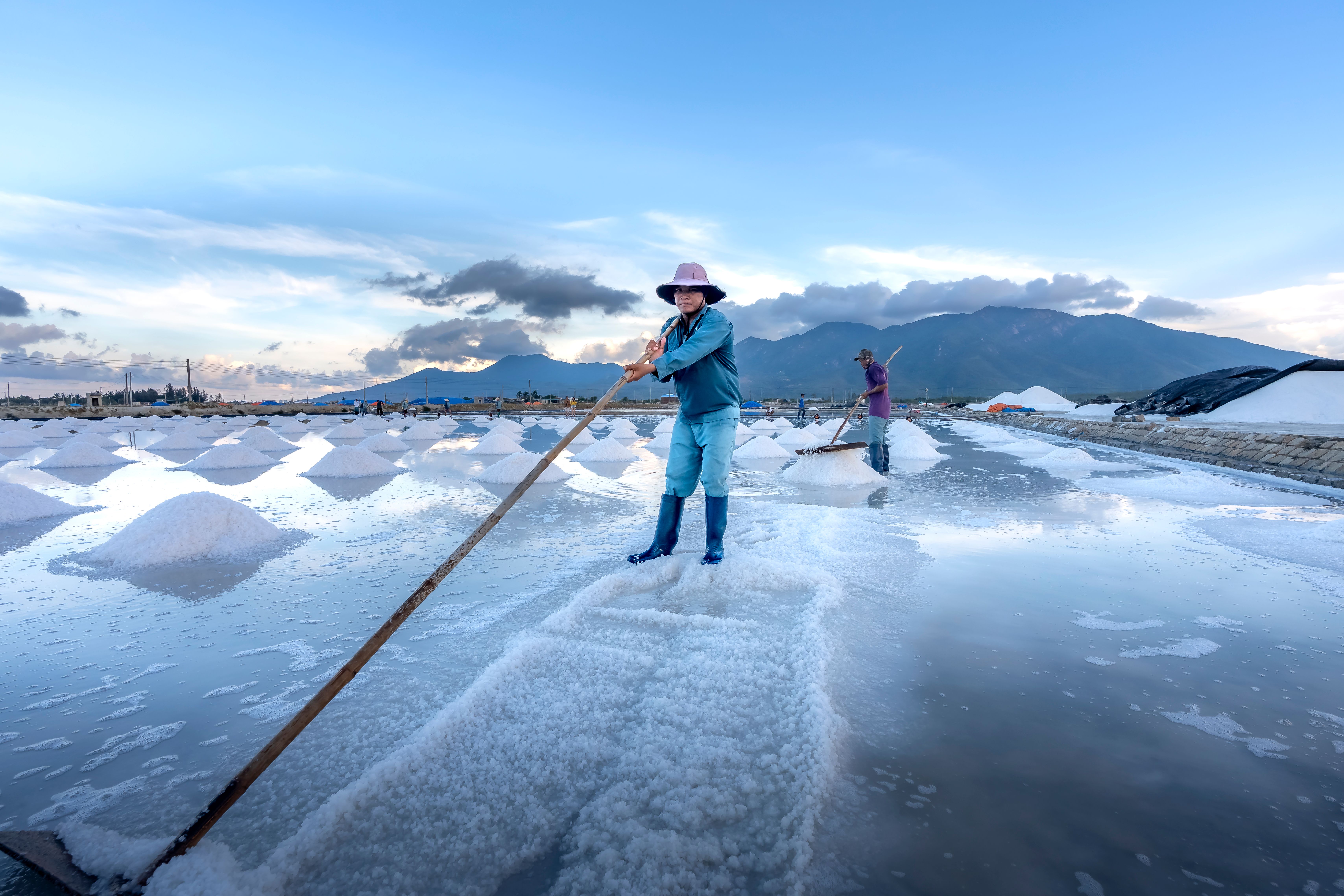 Salt Farmers Harvesting in Serene Landscape · Free Stock Photo
