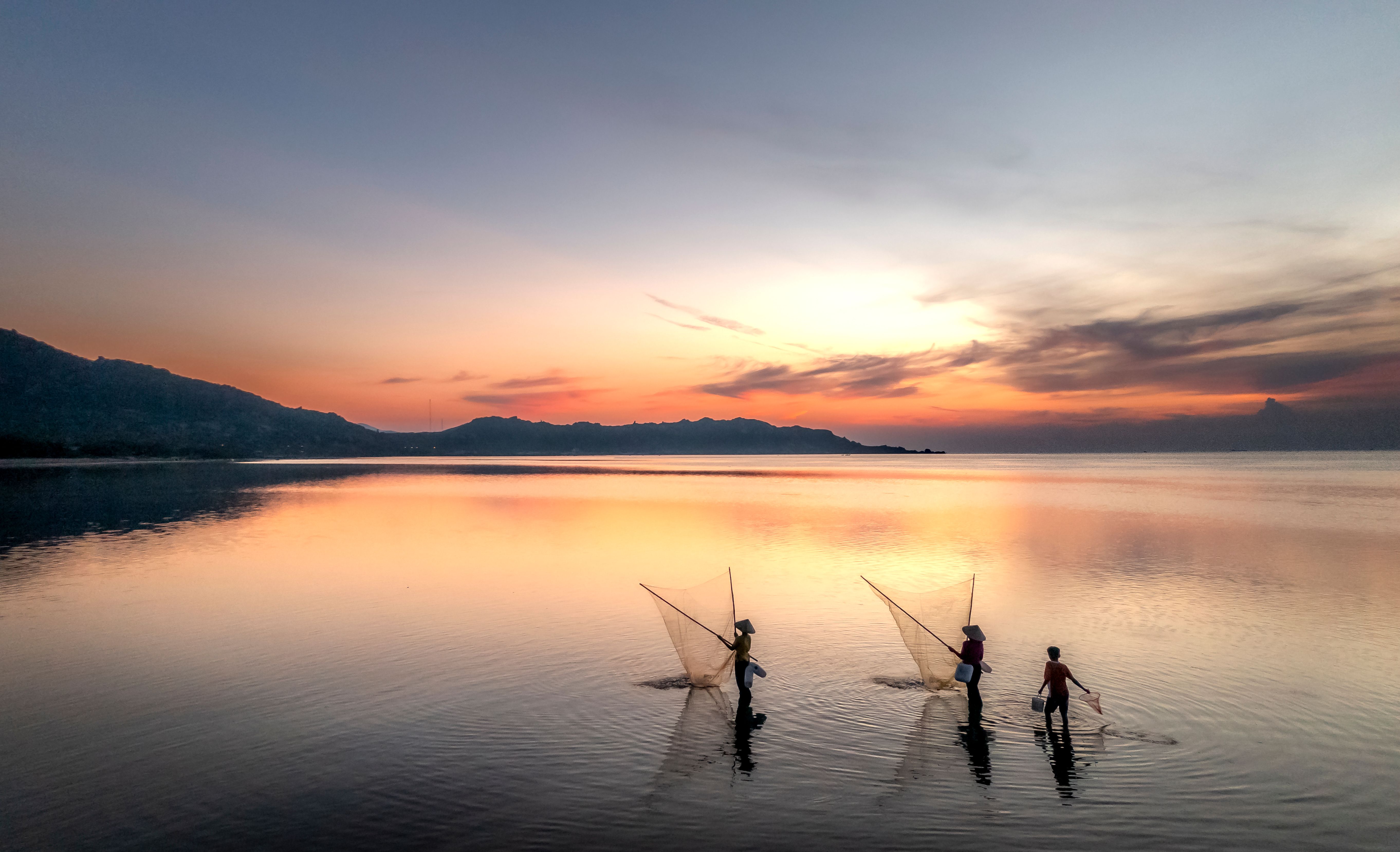 Sunset Fishing Scene in Tranquil Waters · Free Stock Photo