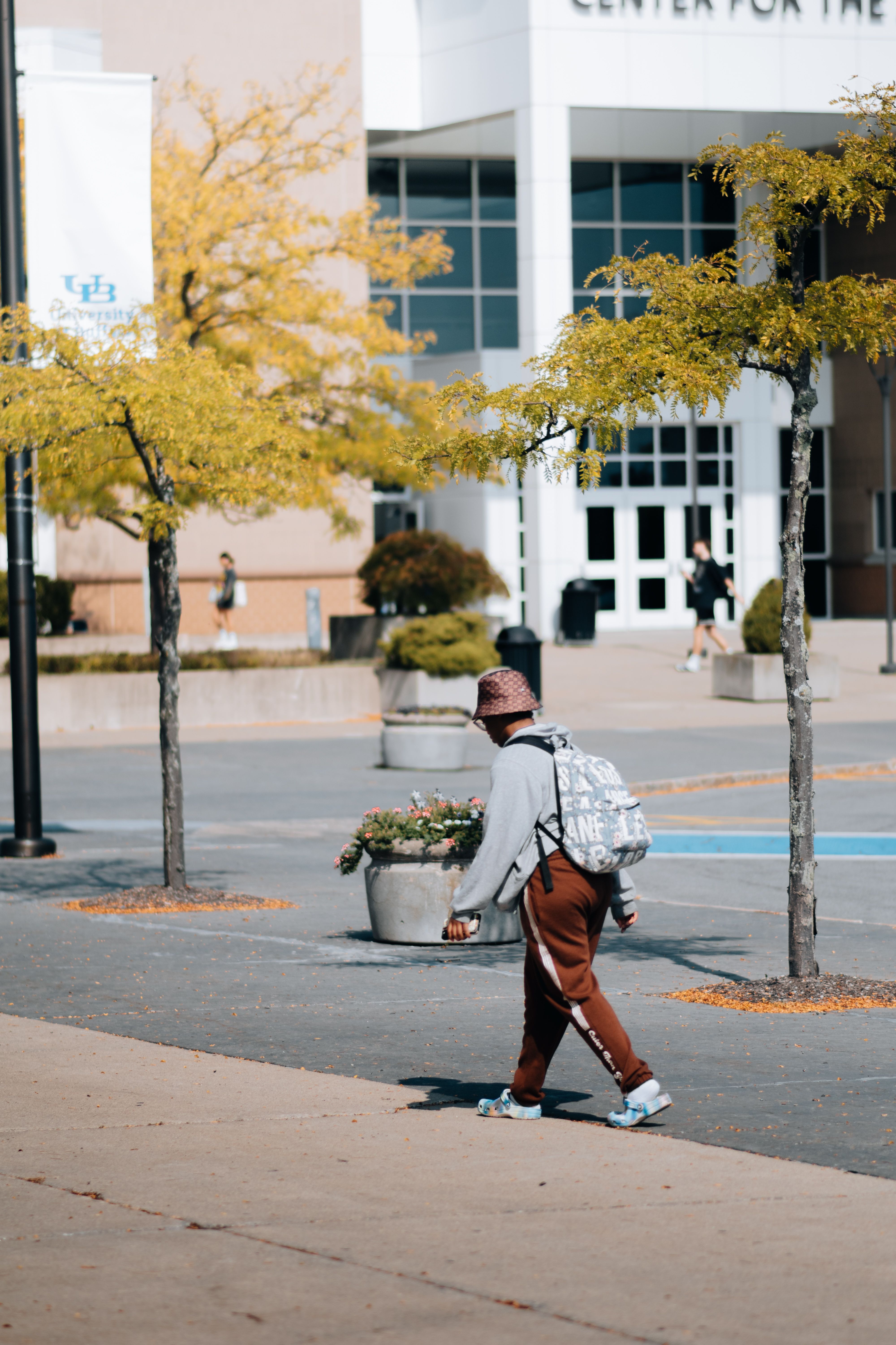 University Campus Scene with Student Walking · Free Stock Photo