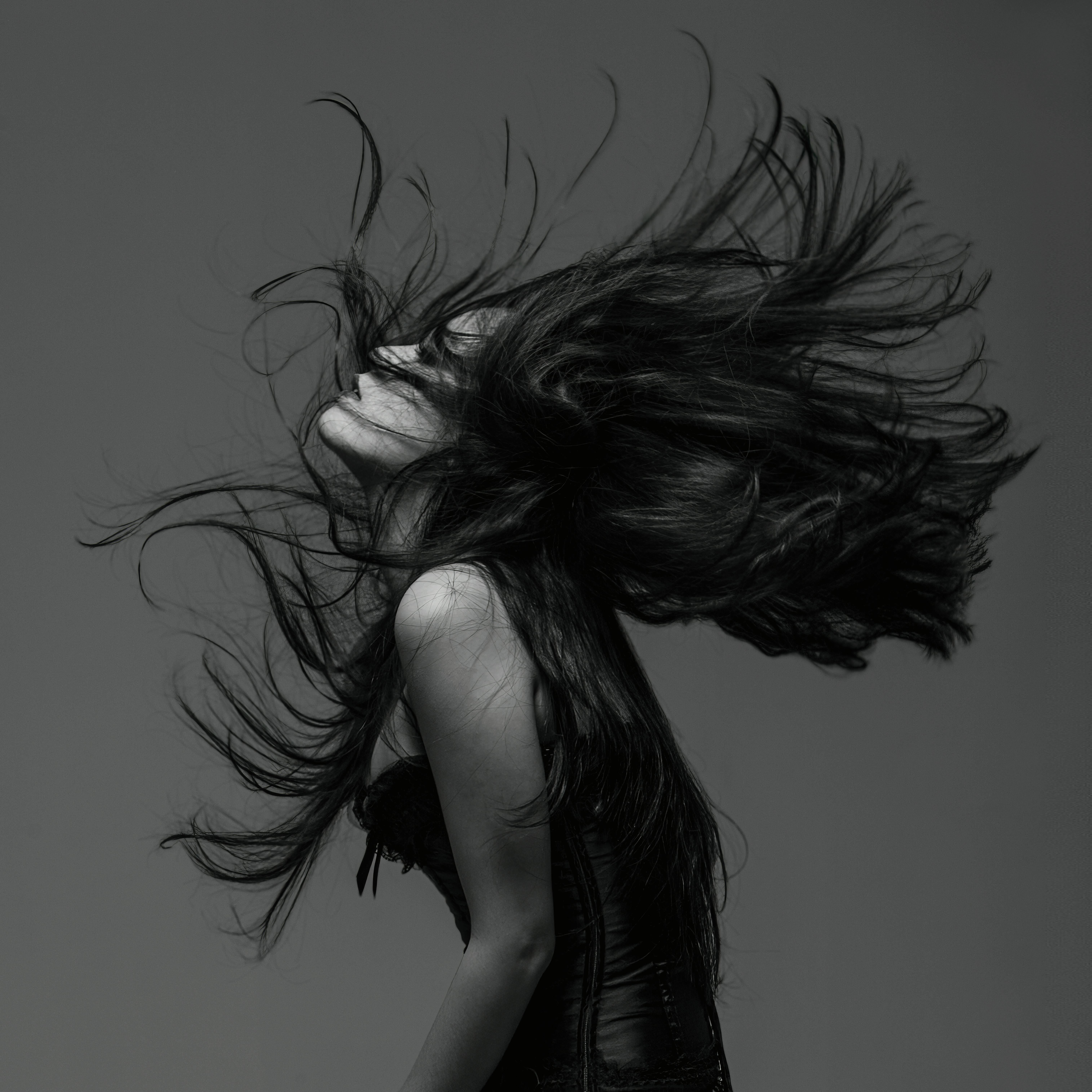Dynamic Black and White Hair Flip Portrait · Free Stock Photo