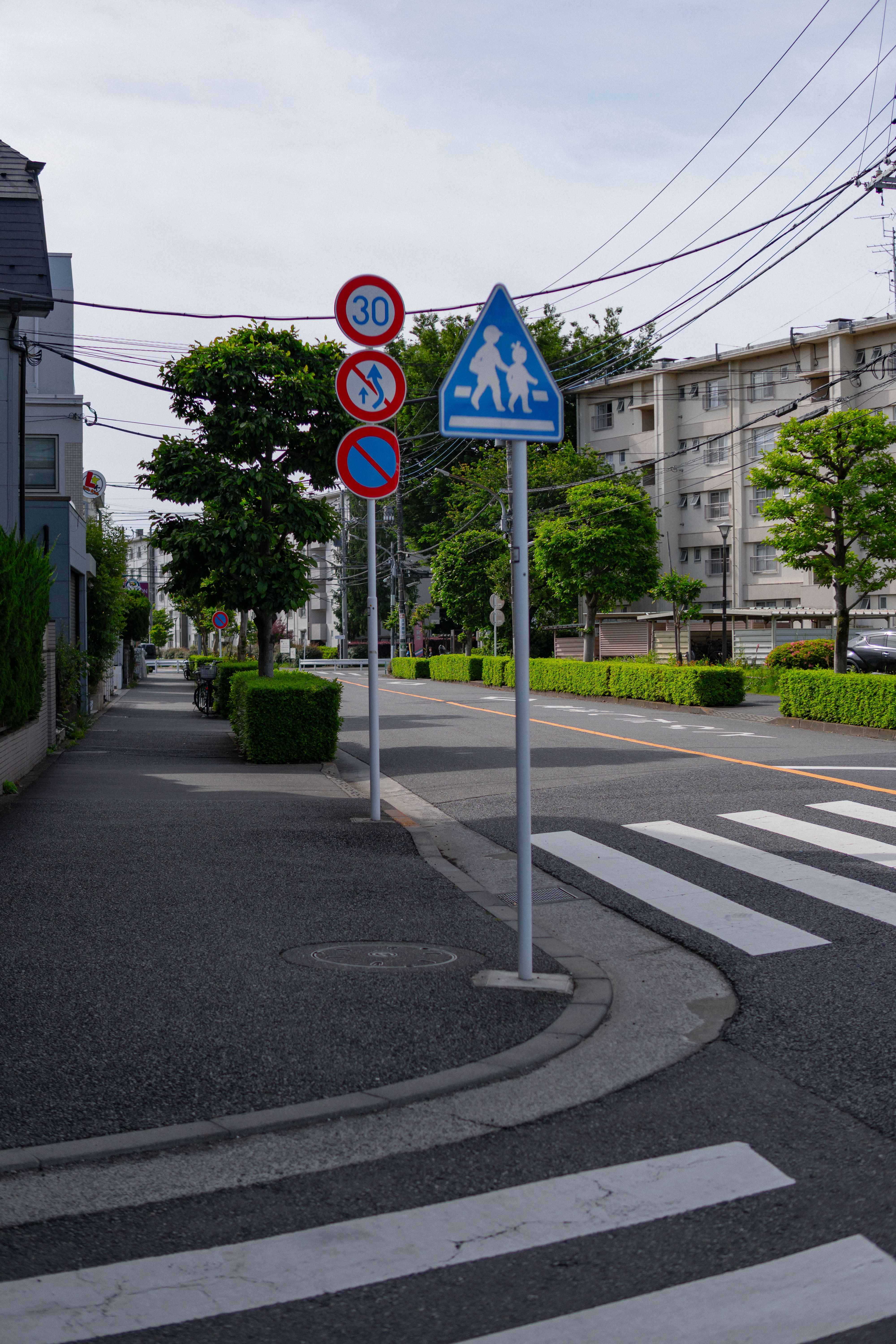 Quiet Urban Street with Traffic Signs · Free Stock Photo