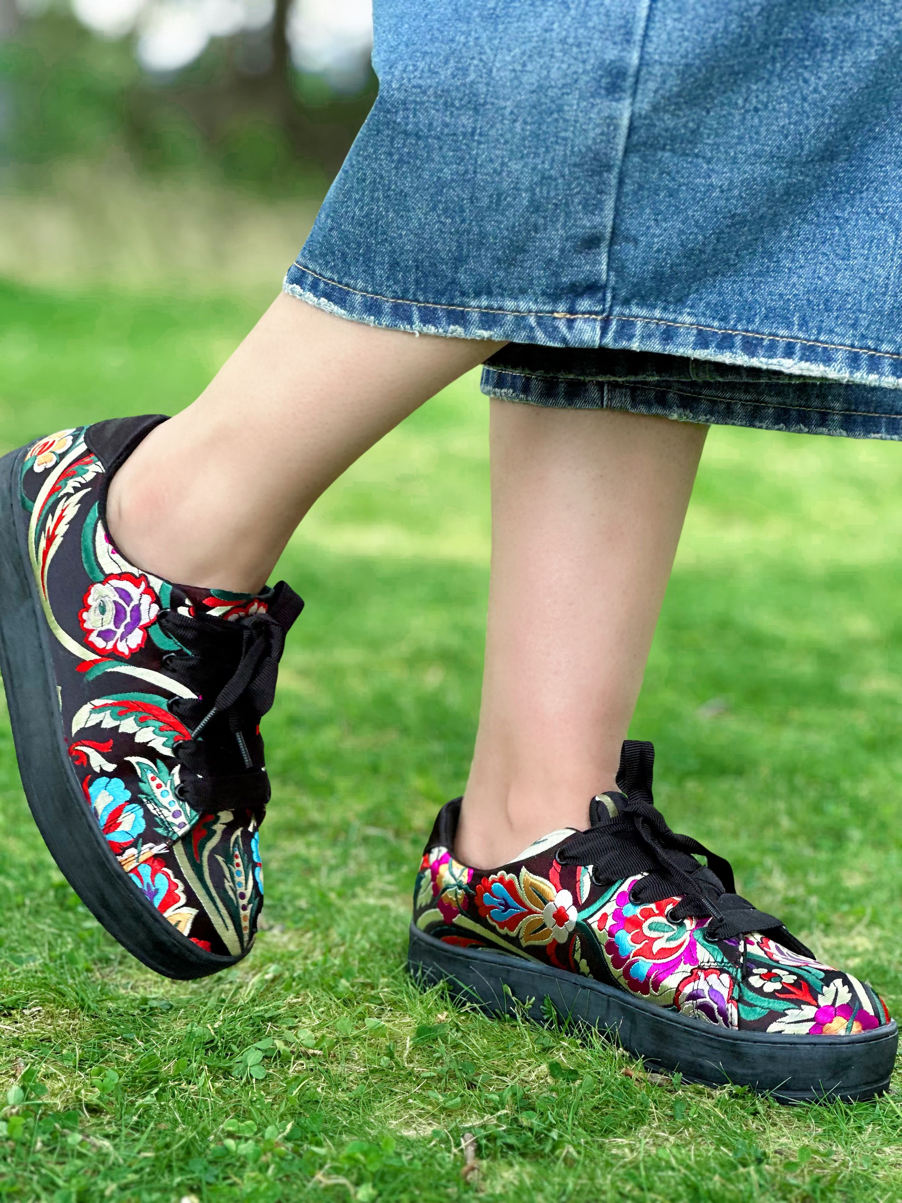 A woman's feet are in the air while wearing colorful shoes · Free Stock ...