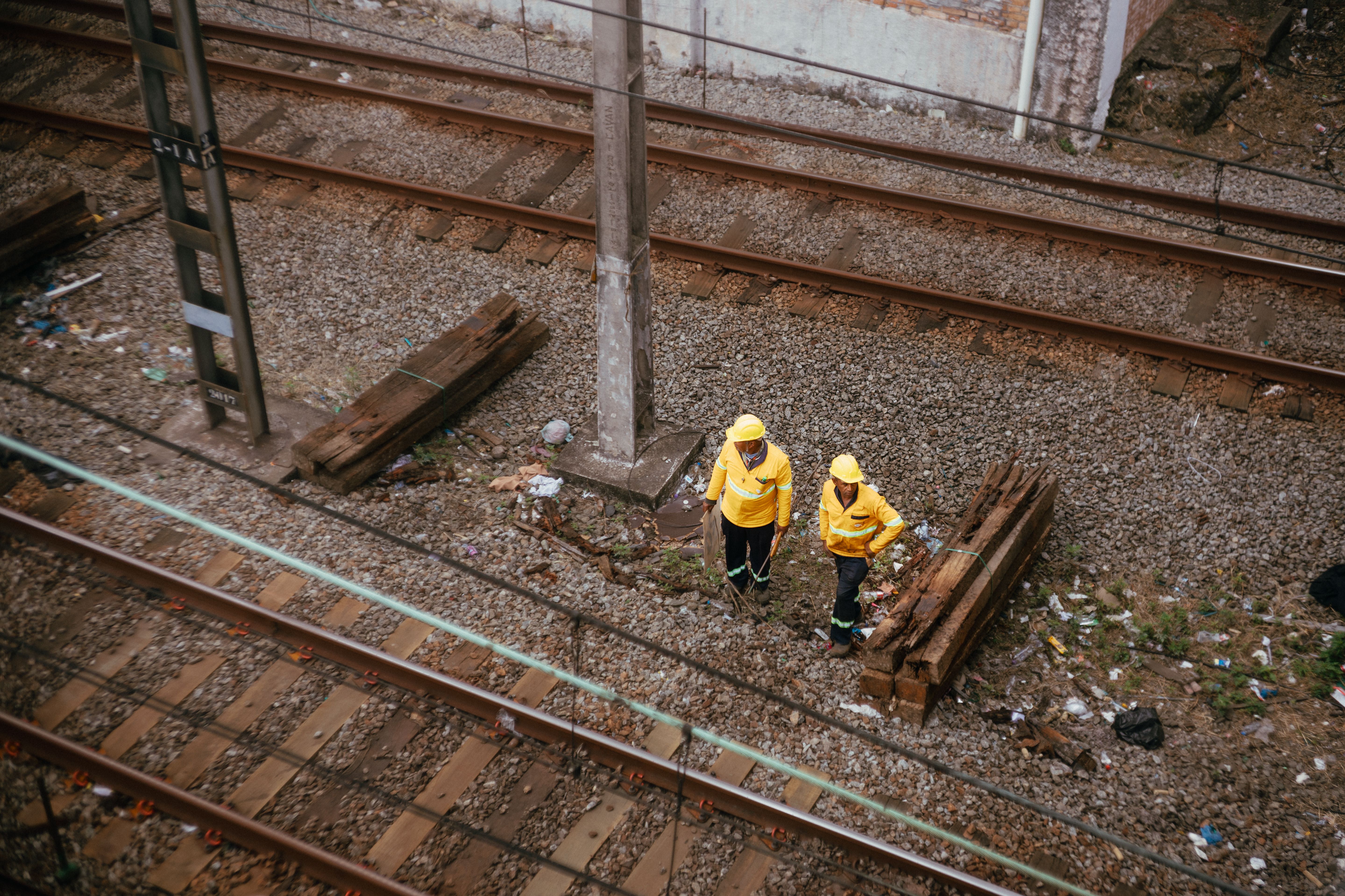 Railway Workers Maintaining Train Tracks from Above · Free Stock Photo