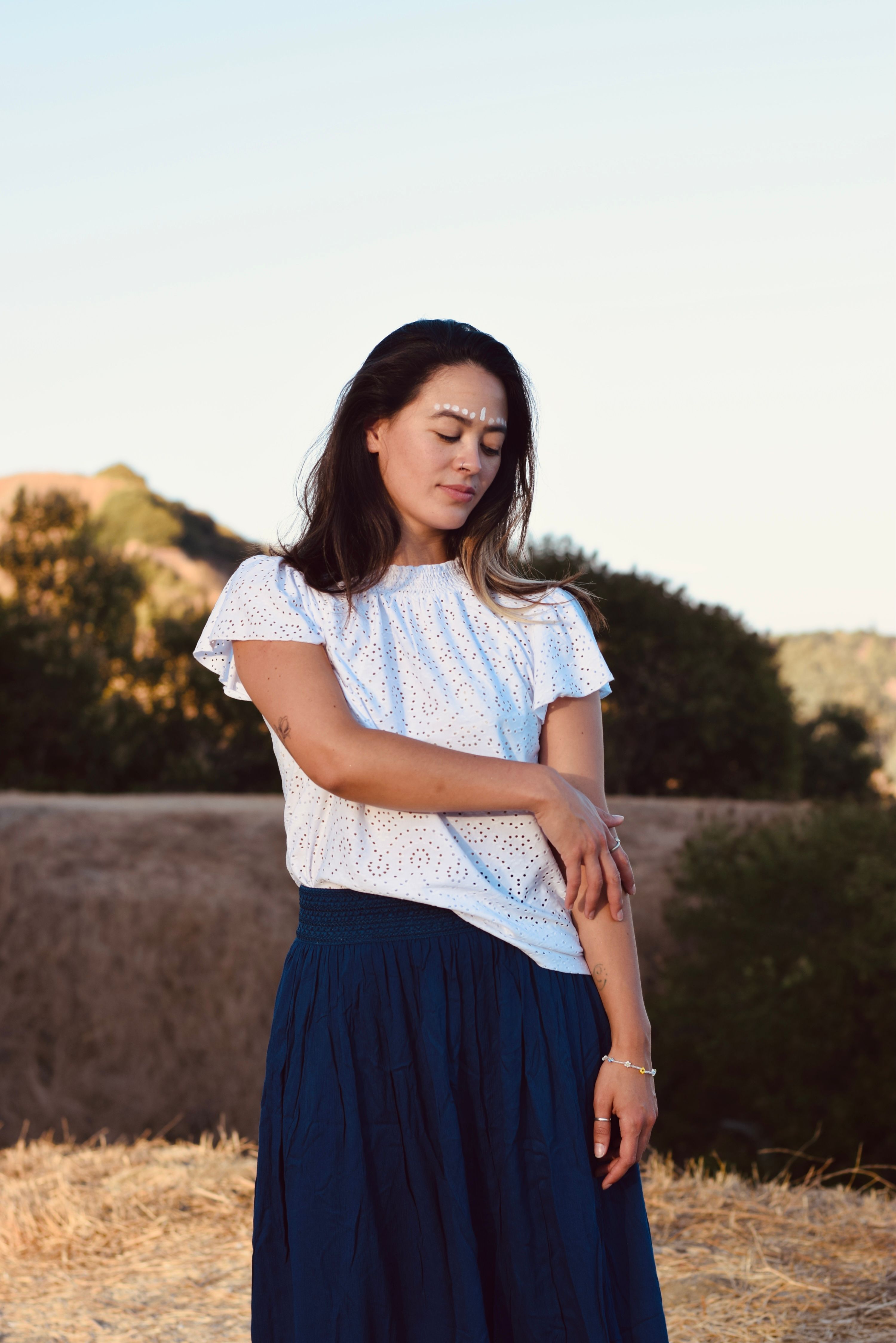 Woman in Nature Embracing Serenity Outdoors · Free Stock Photo