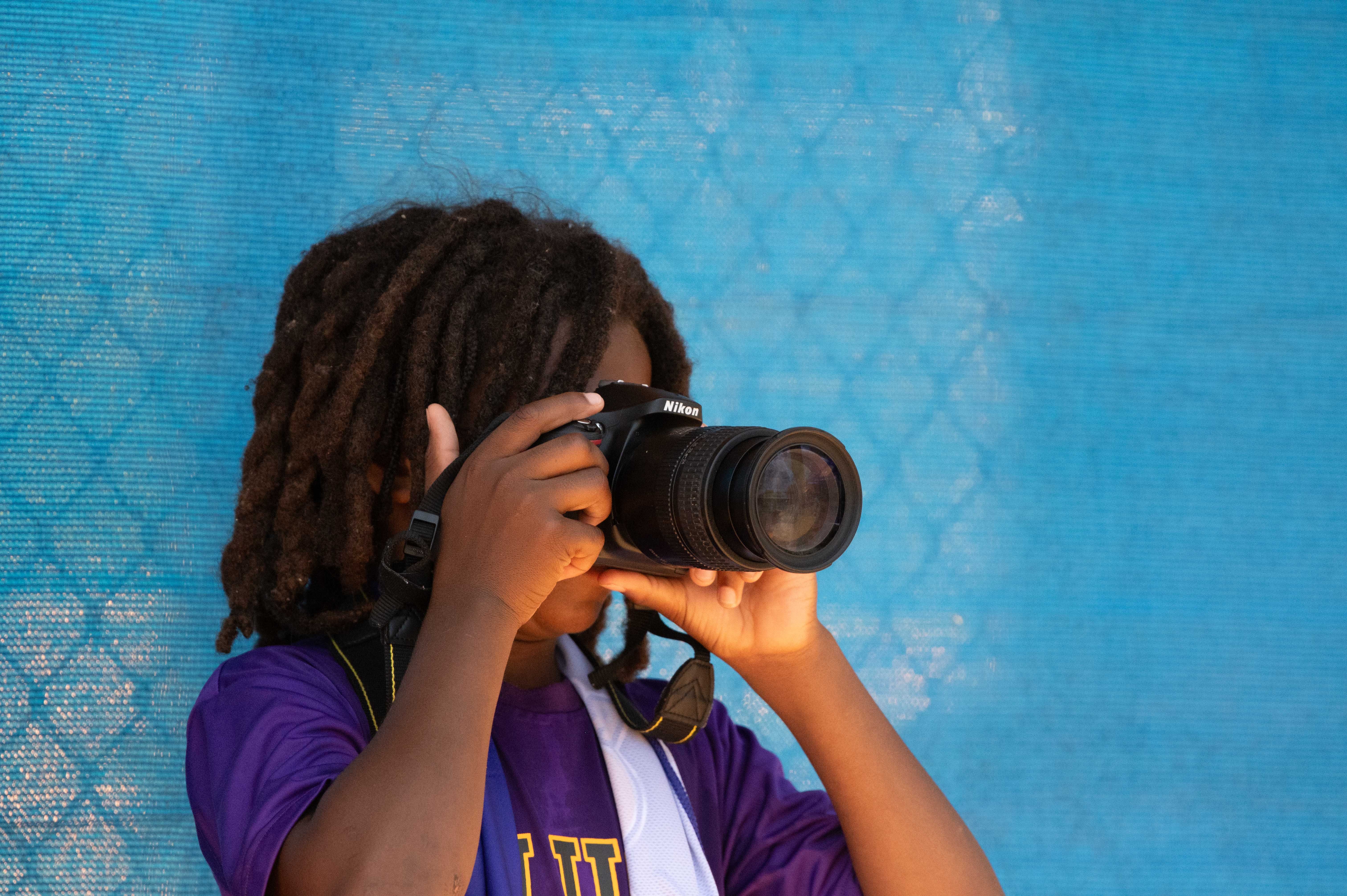 Child with Camera Taking Photos Outdoors · Free Stock Photo