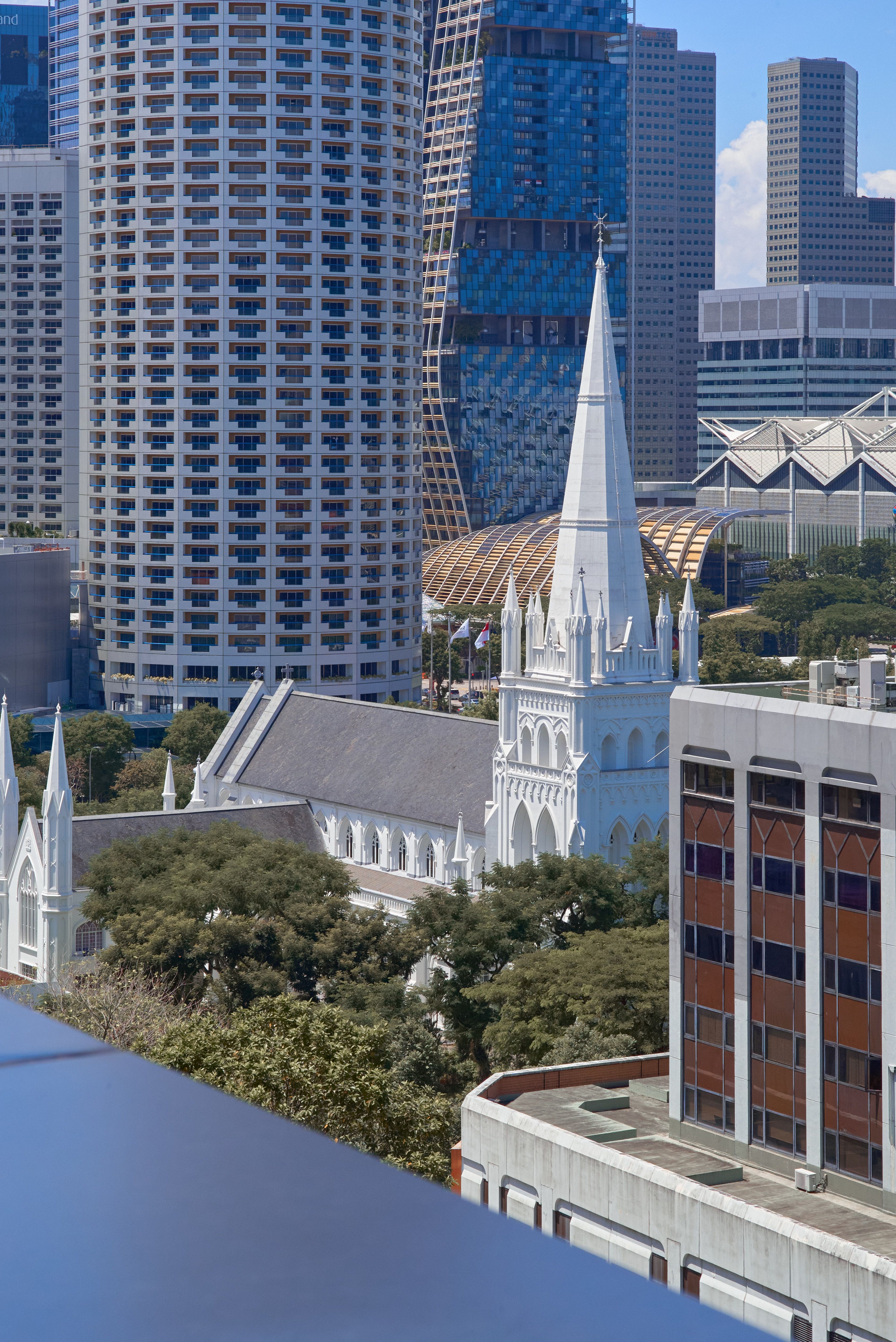 Church Spire Amidst Modern Cityscape · Free Stock Photo