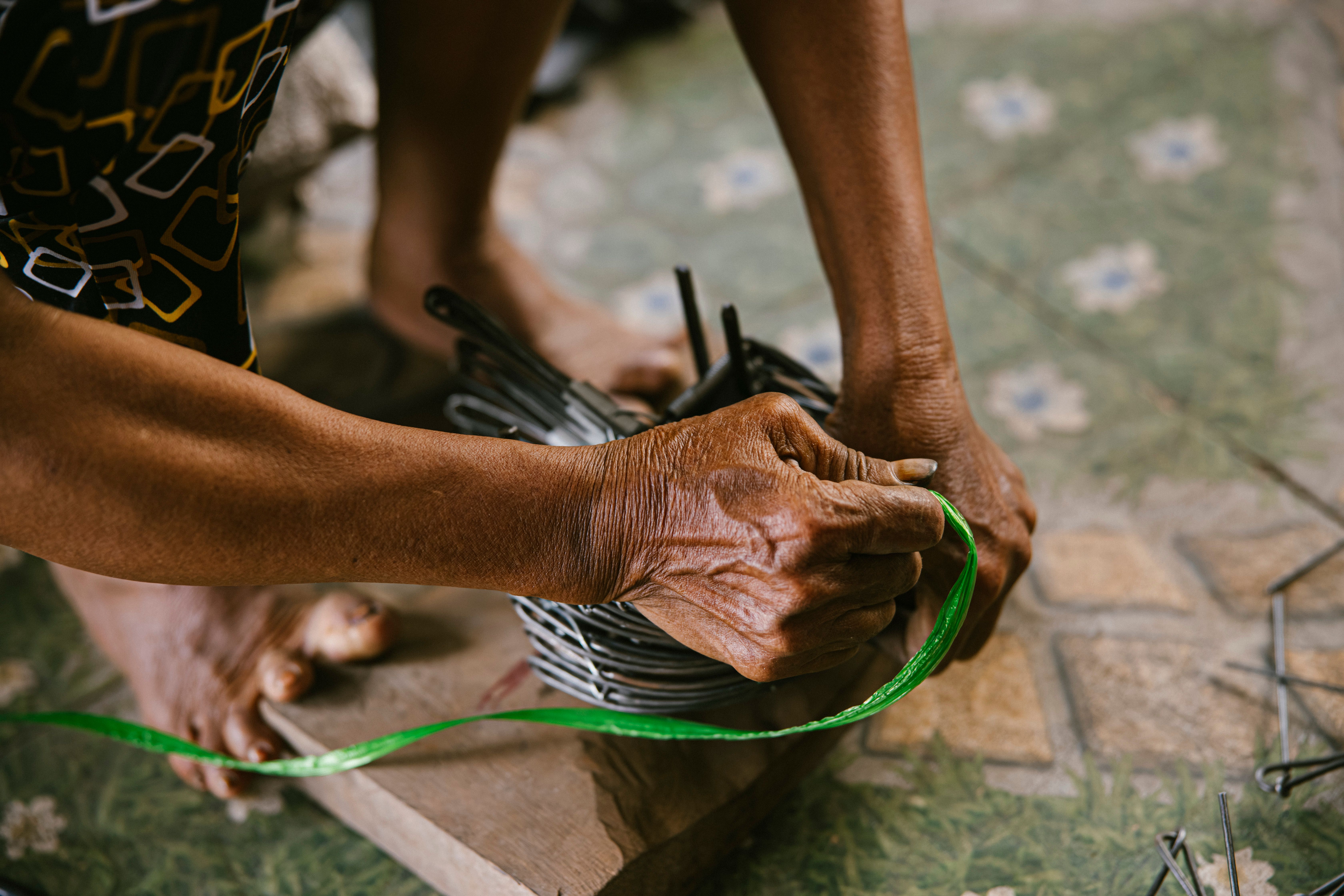 Hand Crafting With Wire on Decorative Floor · Free Stock Photo