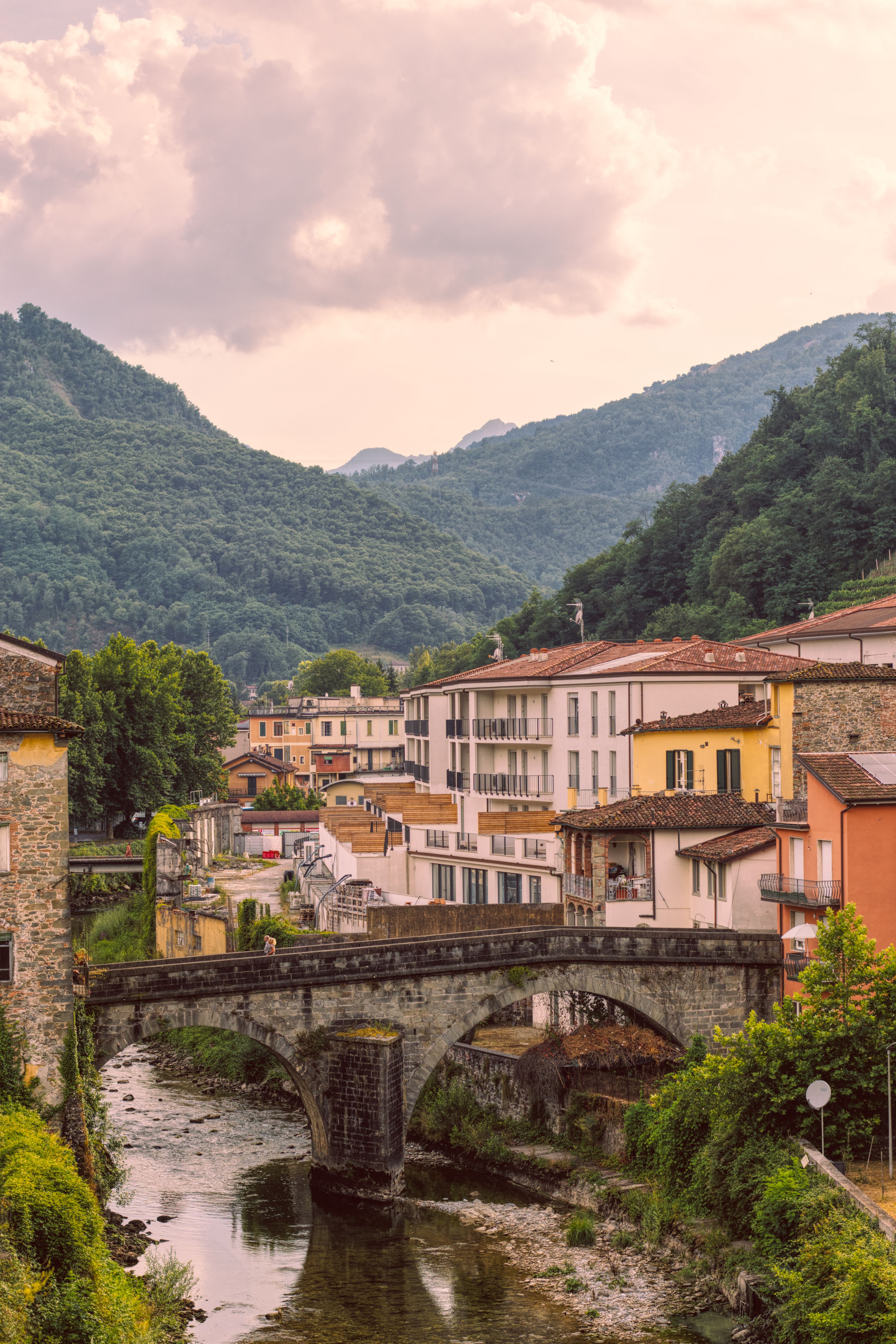 Quaint Italian Village Scene with Bridge and Mountains · Free Stock Photo