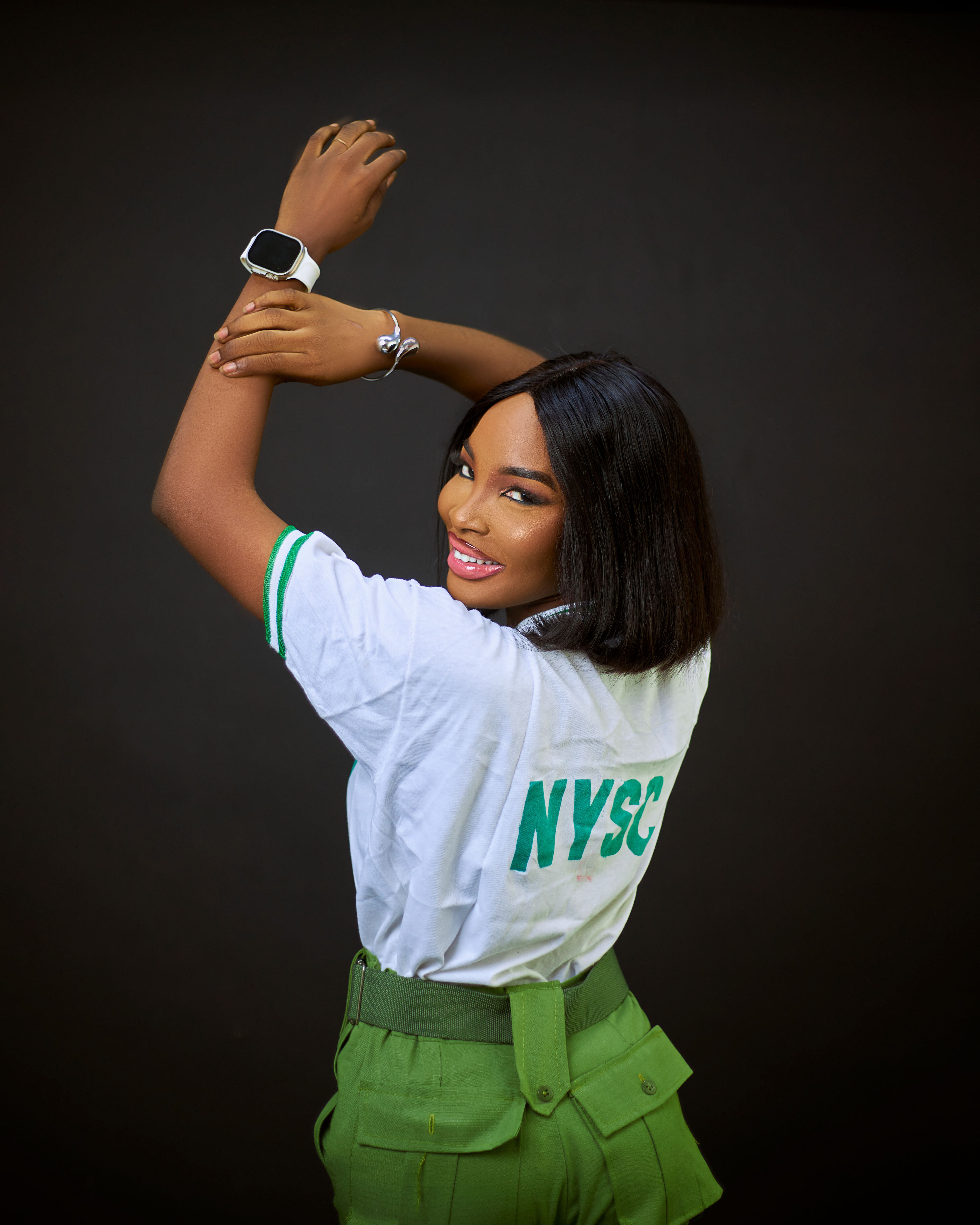 Smiling Young Adult in NYSC Uniform Posing · Free Stock Photo