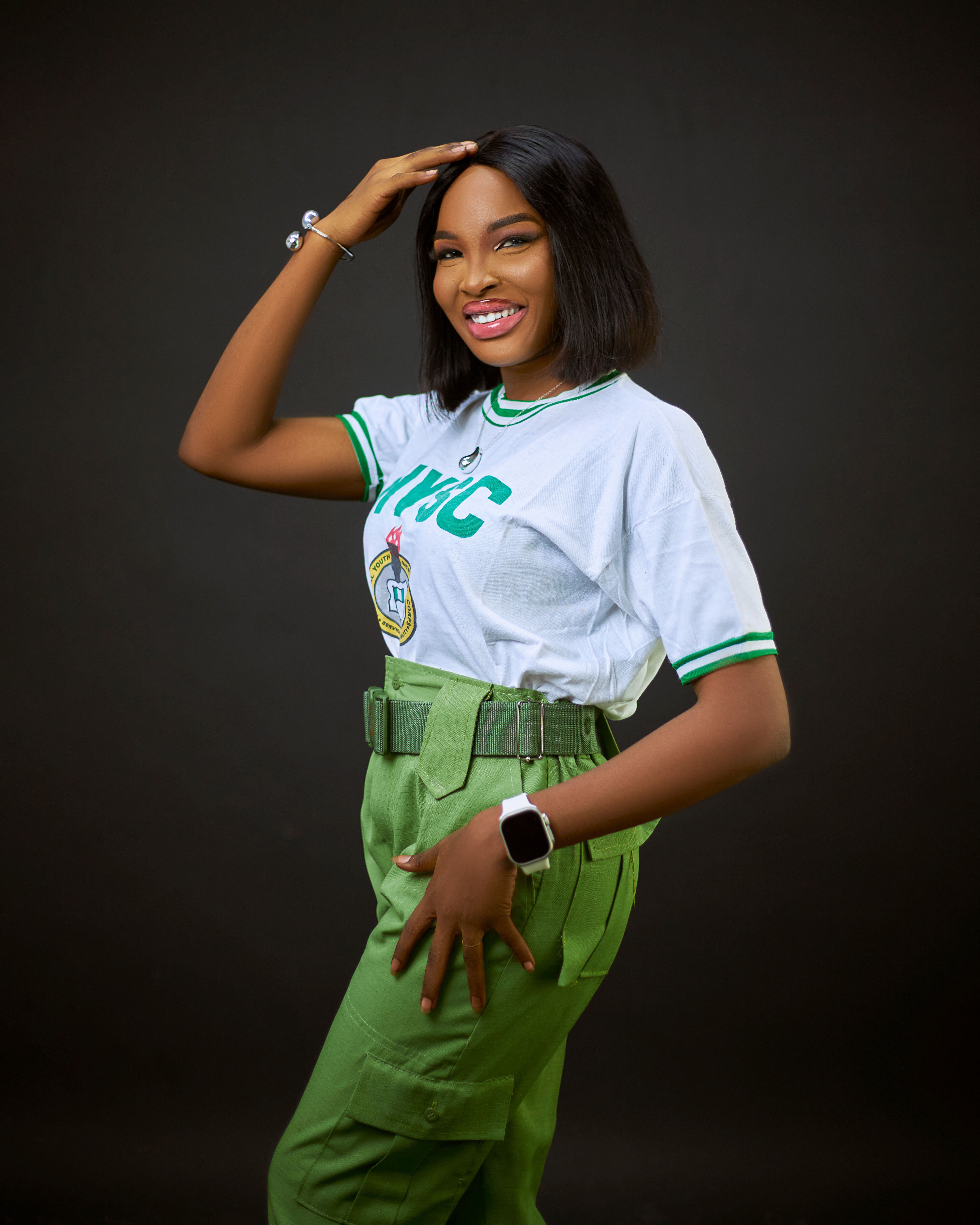 Young Adult in NYSC Uniform Posing Indoors · Free Stock Photo
