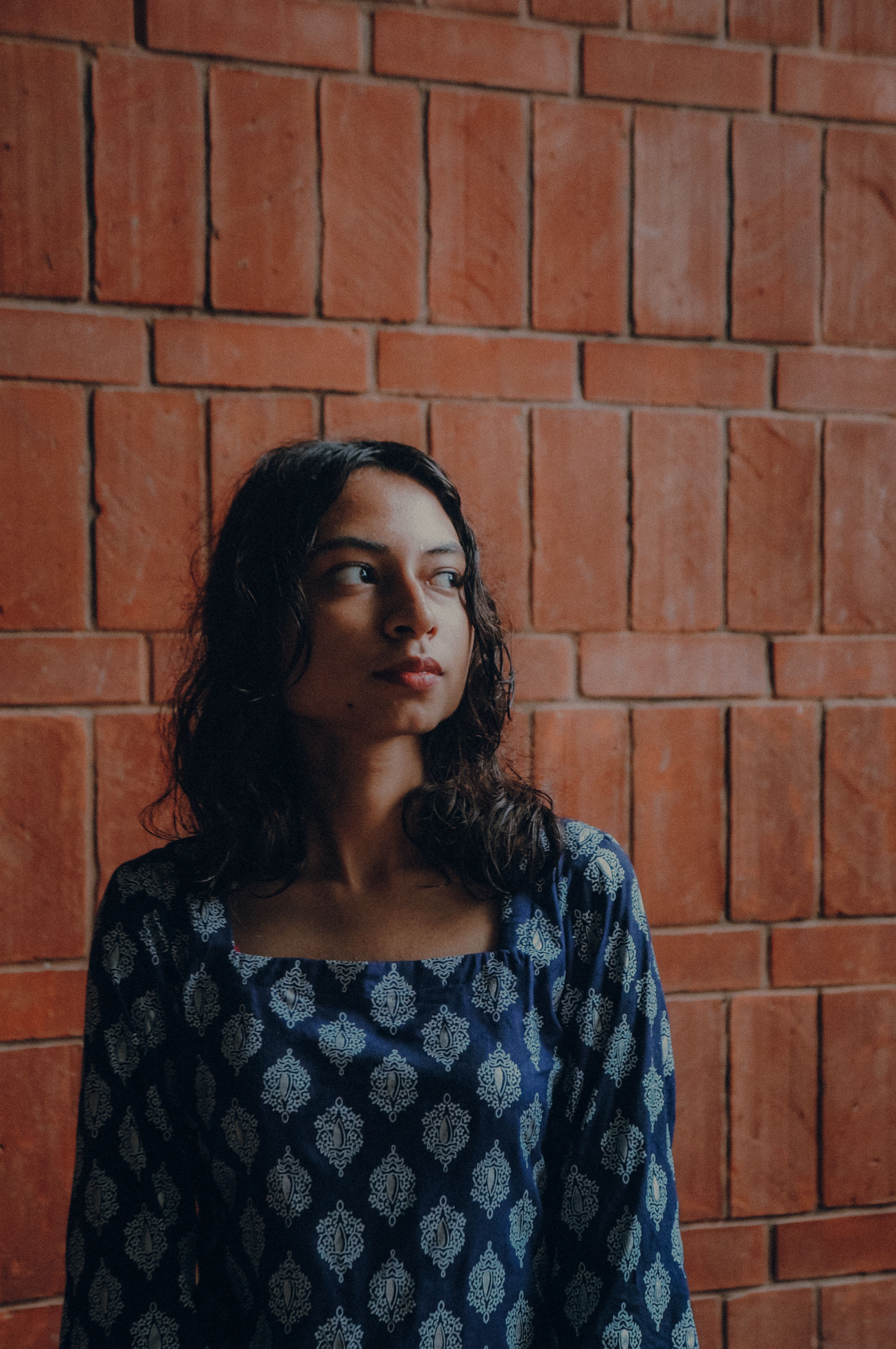 Reflective Woman in Traditional Attire by Window · Free Stock Photo