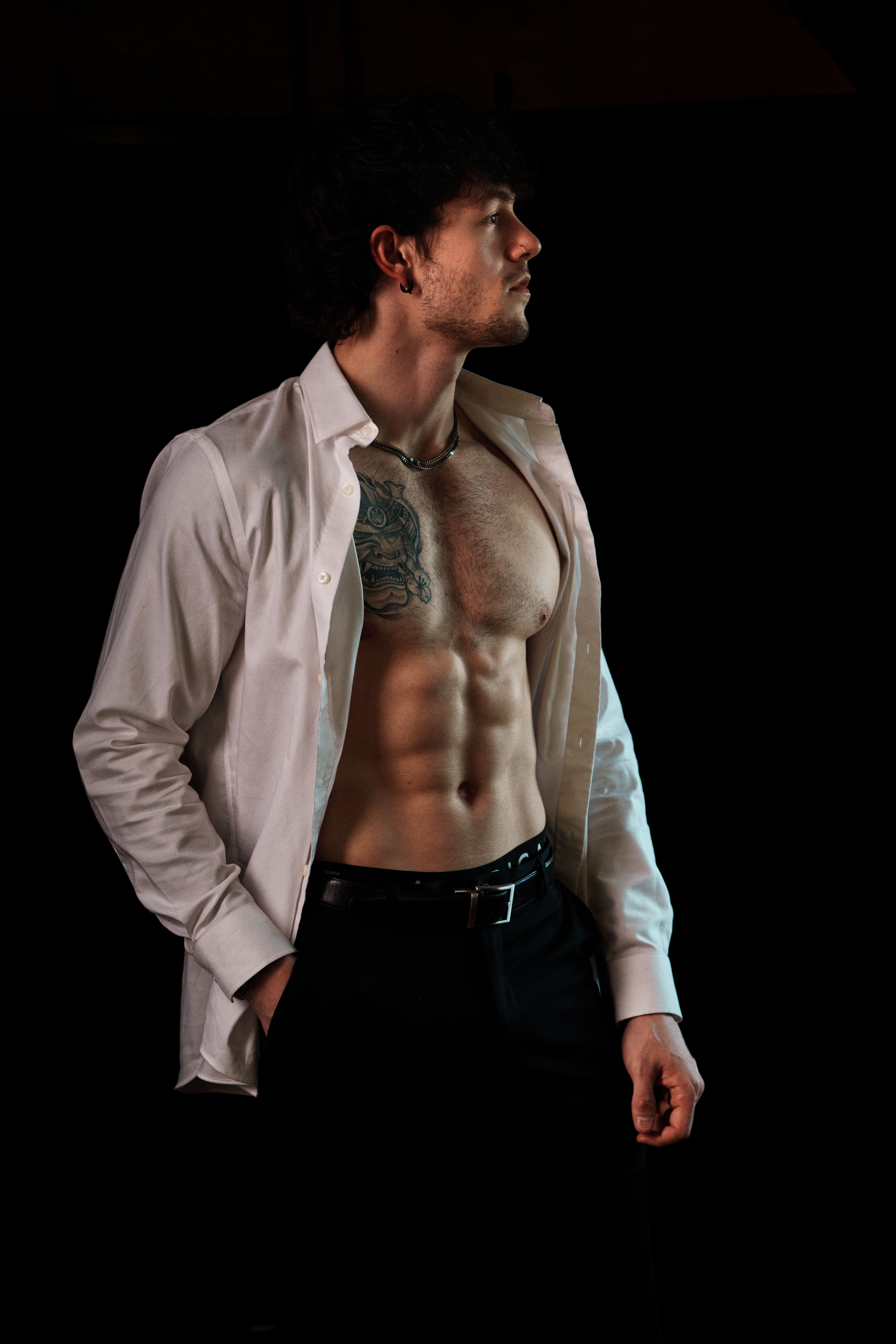 Muscular Man Posing In Open Shirt Against Black Background Free Stock