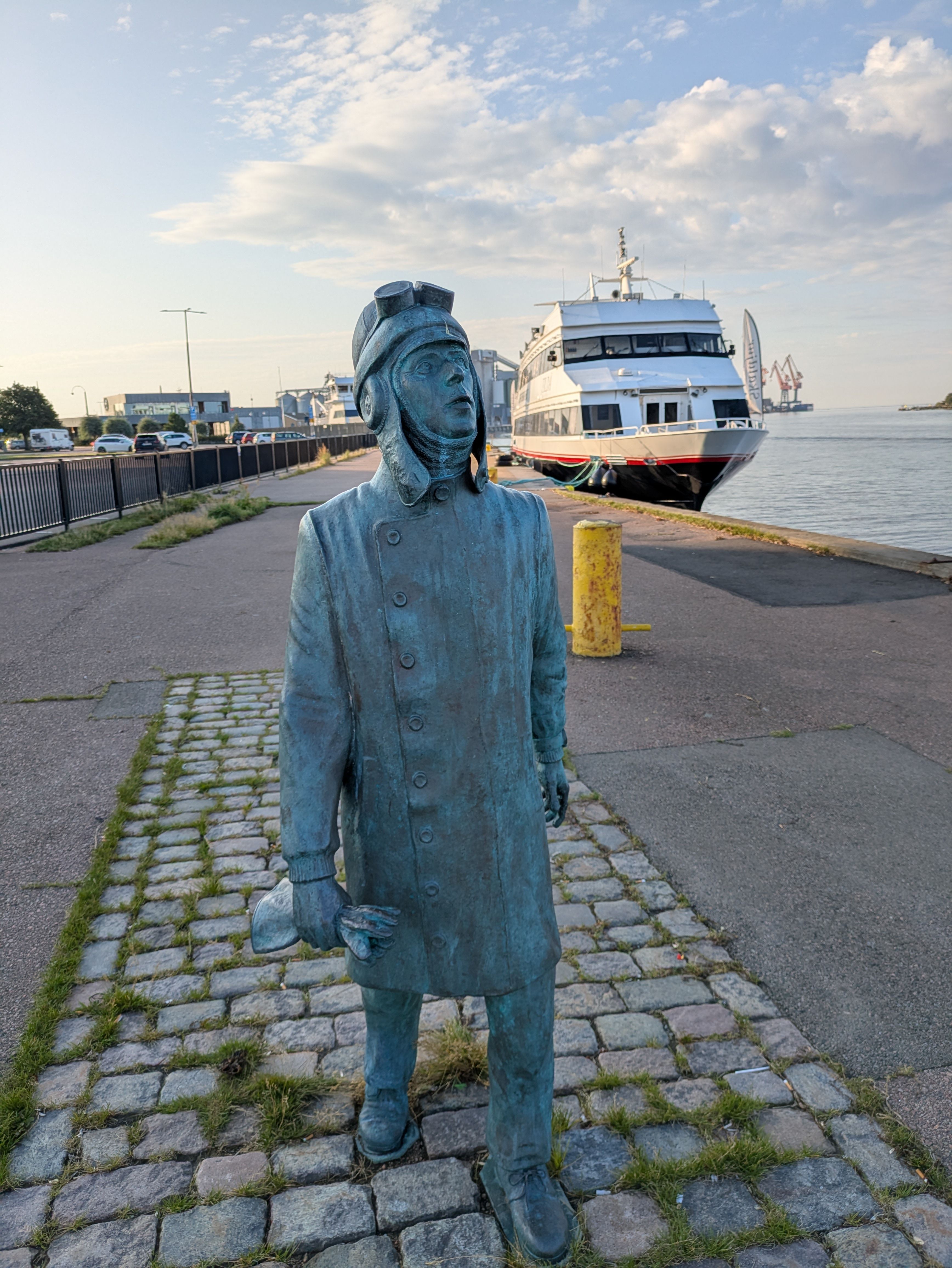 Bronze Statue Near Ship at Harborside · Free Stock Photo