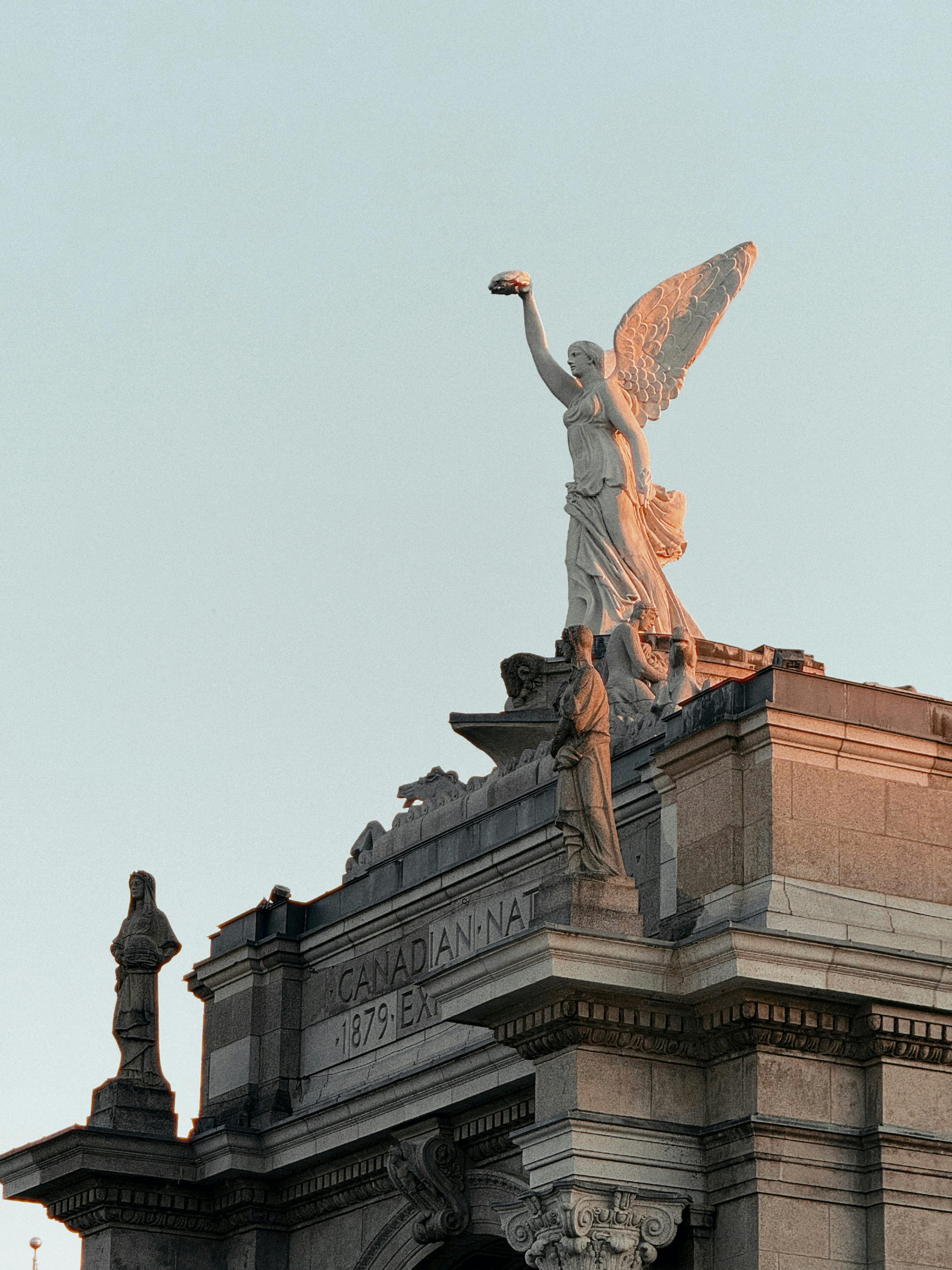 Angel Statue on Historic Toronto Building at Golden Hour · Free Stock Photo