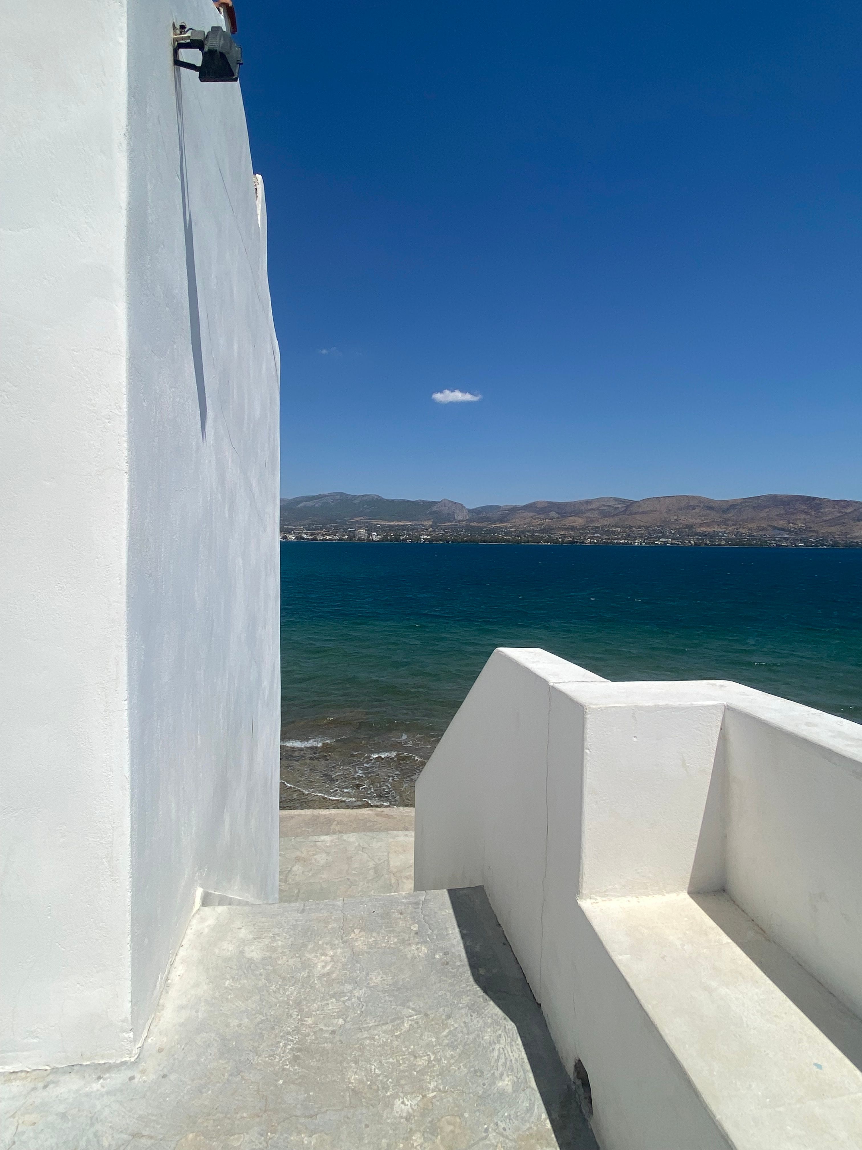 Serene Seaside View with Greek Architecture · Free Stock Photo