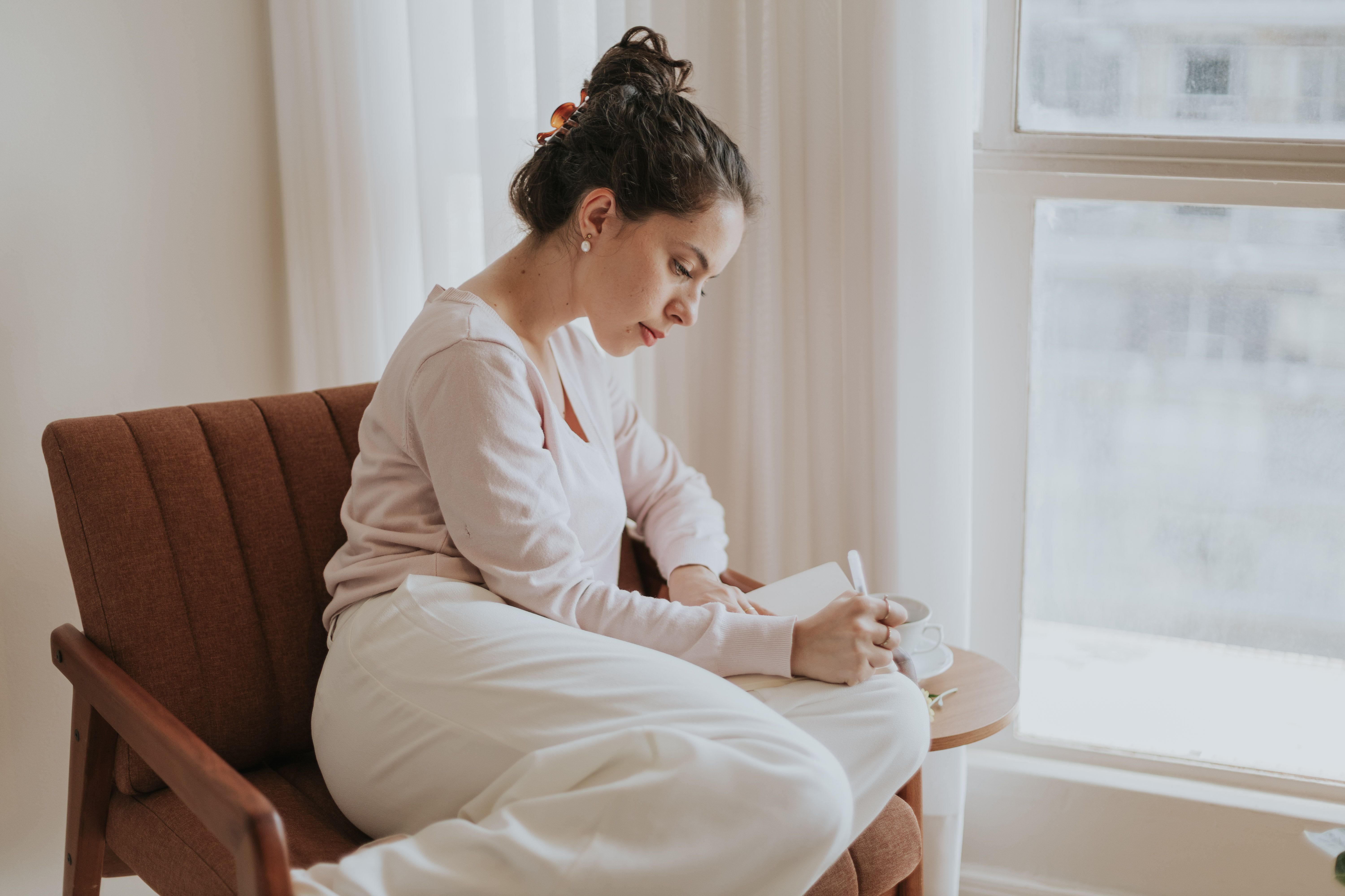 Relaxed Journaling by the Window in Natural Light · Free Stock Photo