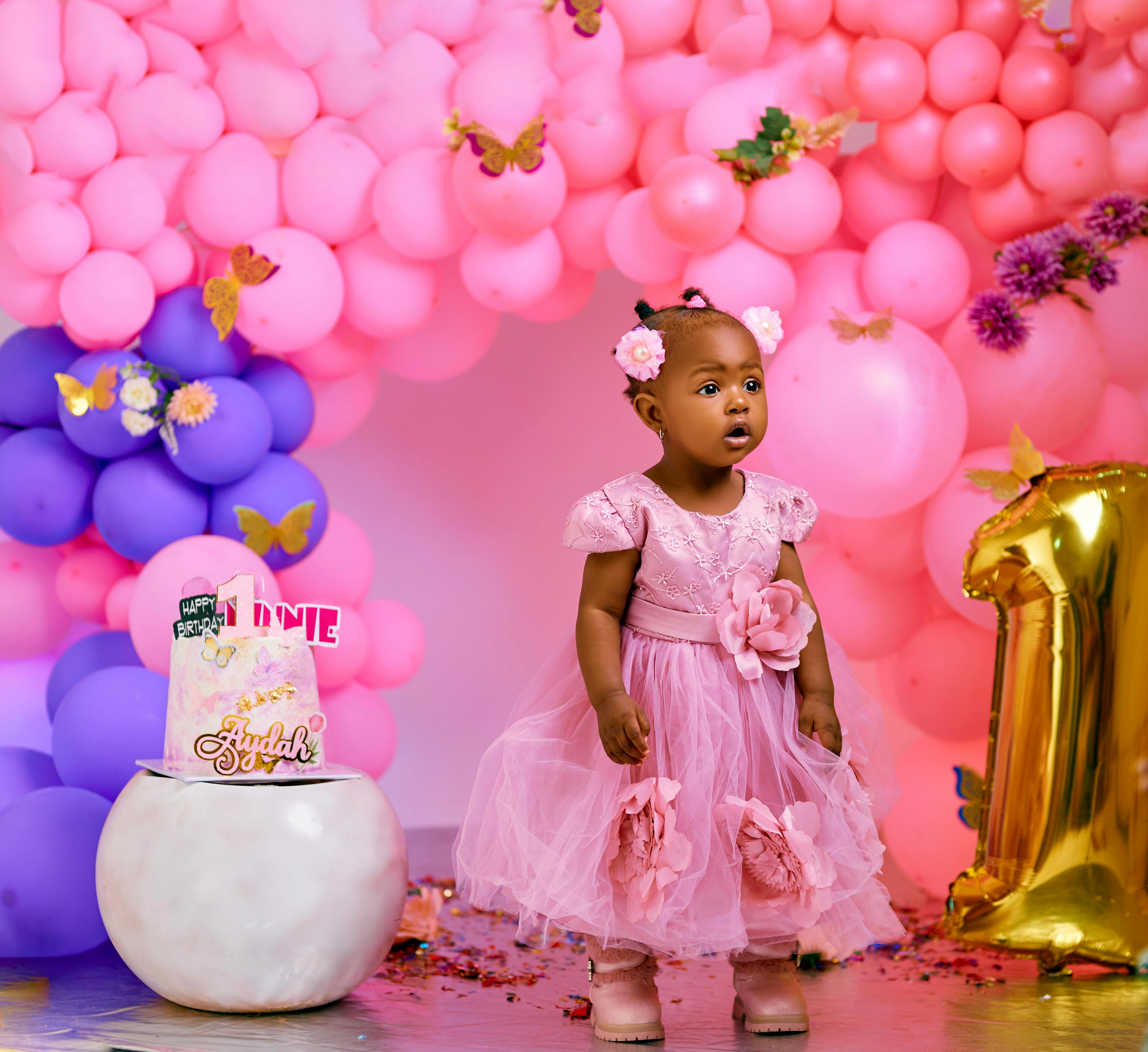 Joyful Toddler's Birthday Party with Pink Balloons · Free Stock Photo