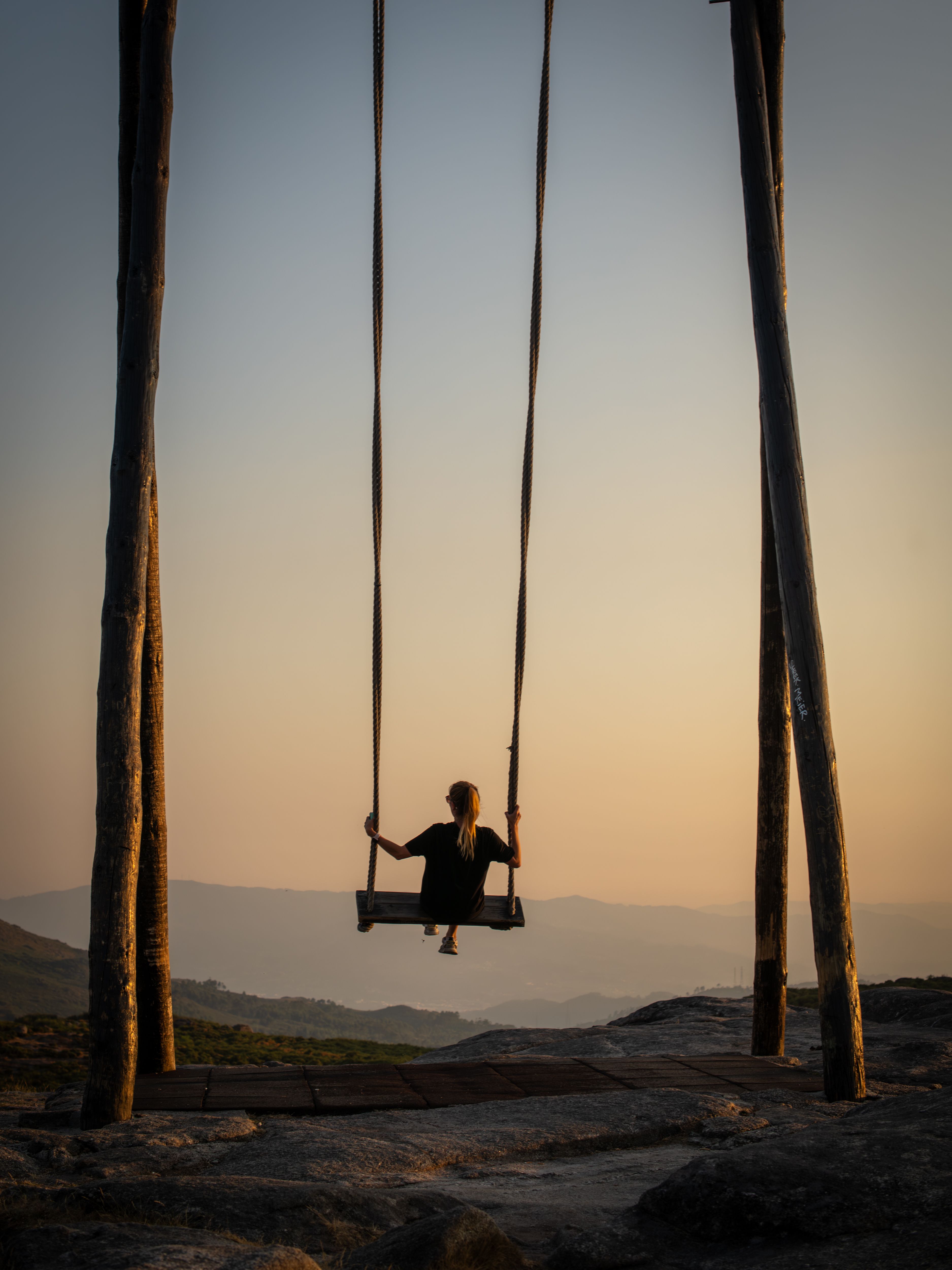 Woman Enjoying a Sunset Swing in Portugal · Free Stock Photo
