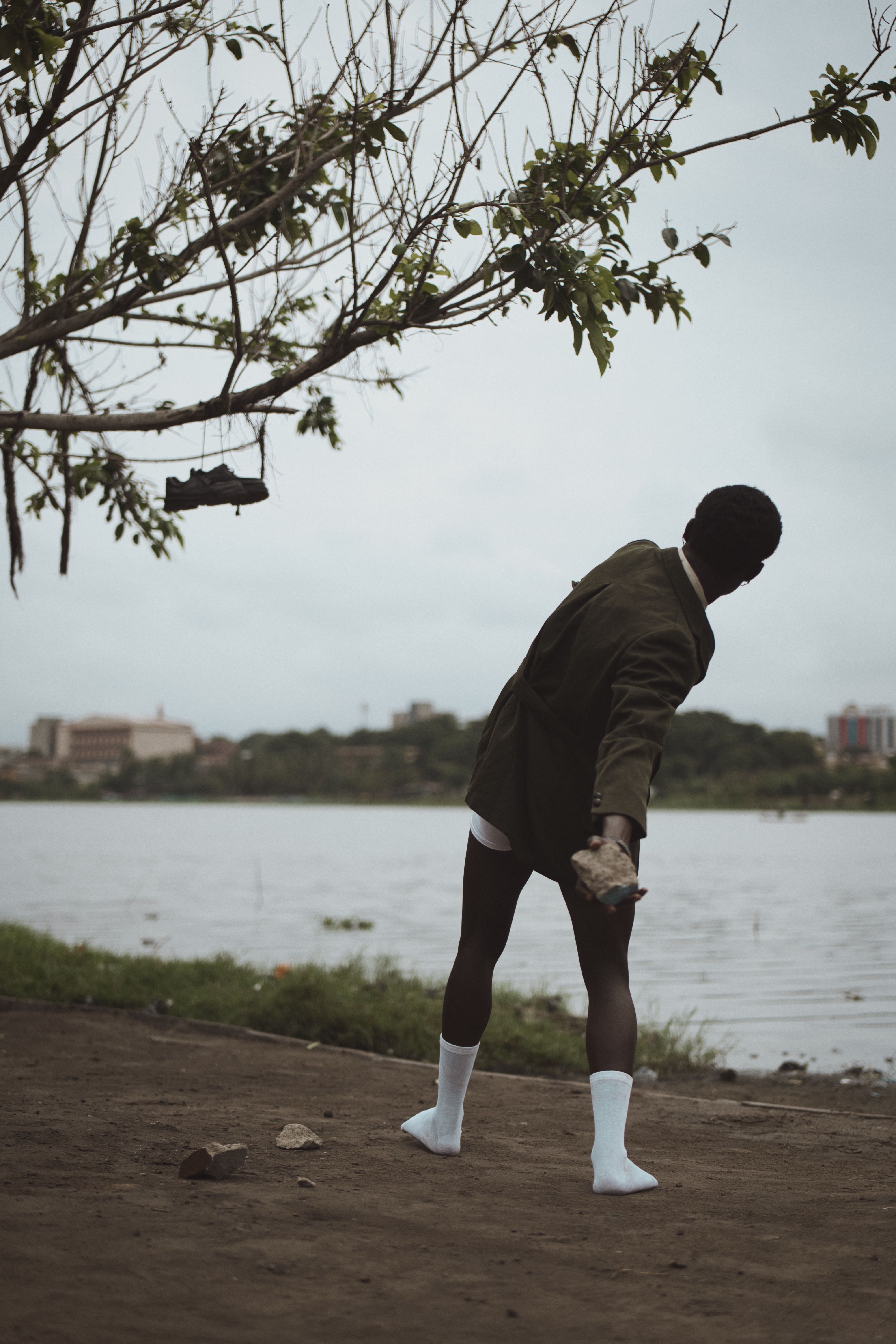Dramatic Pose by Riverside in Urban Setting · Free Stock Photo