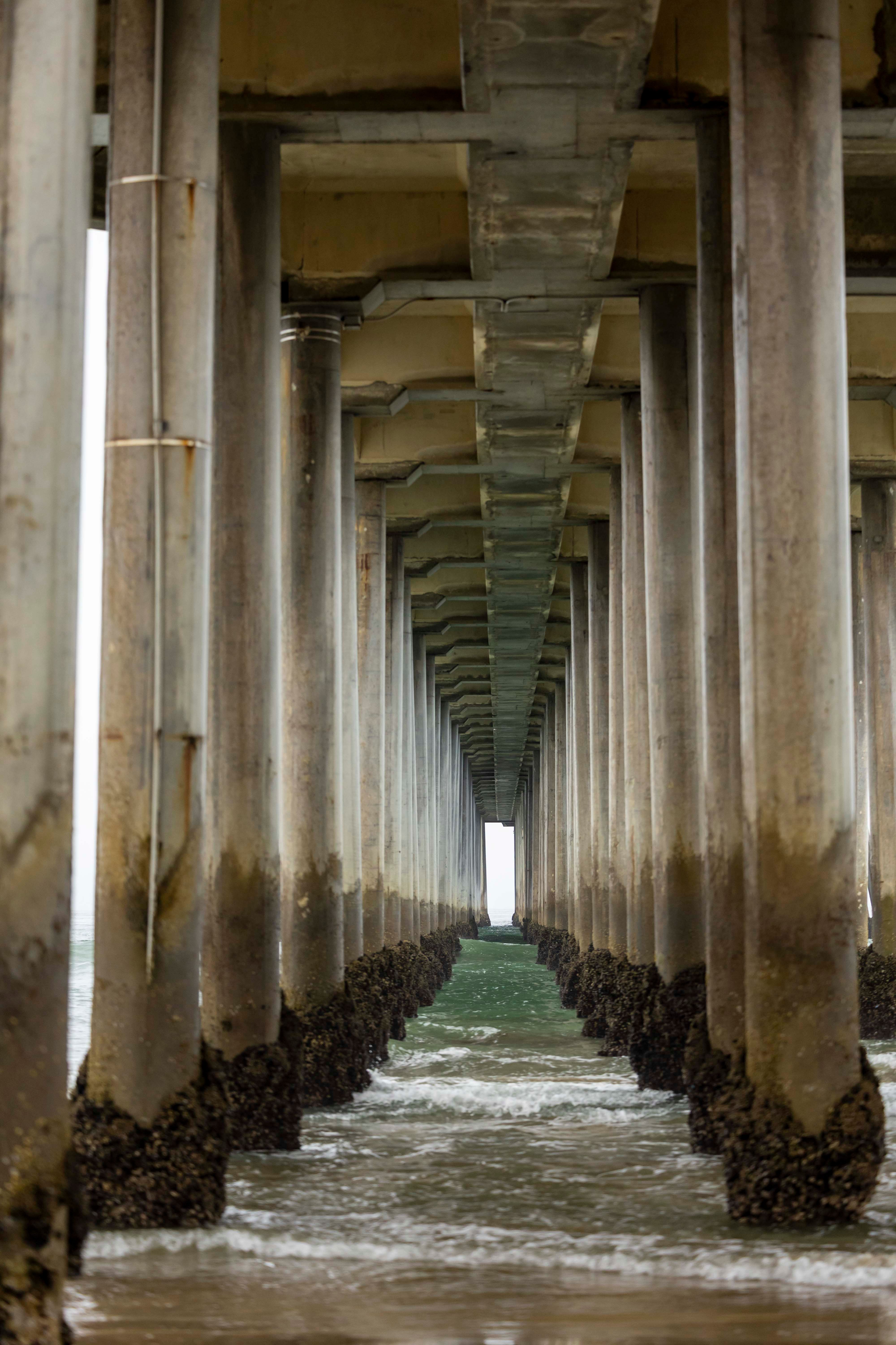 Dramatic View Under Pier with Ocean Waves · Free Stock Photo
