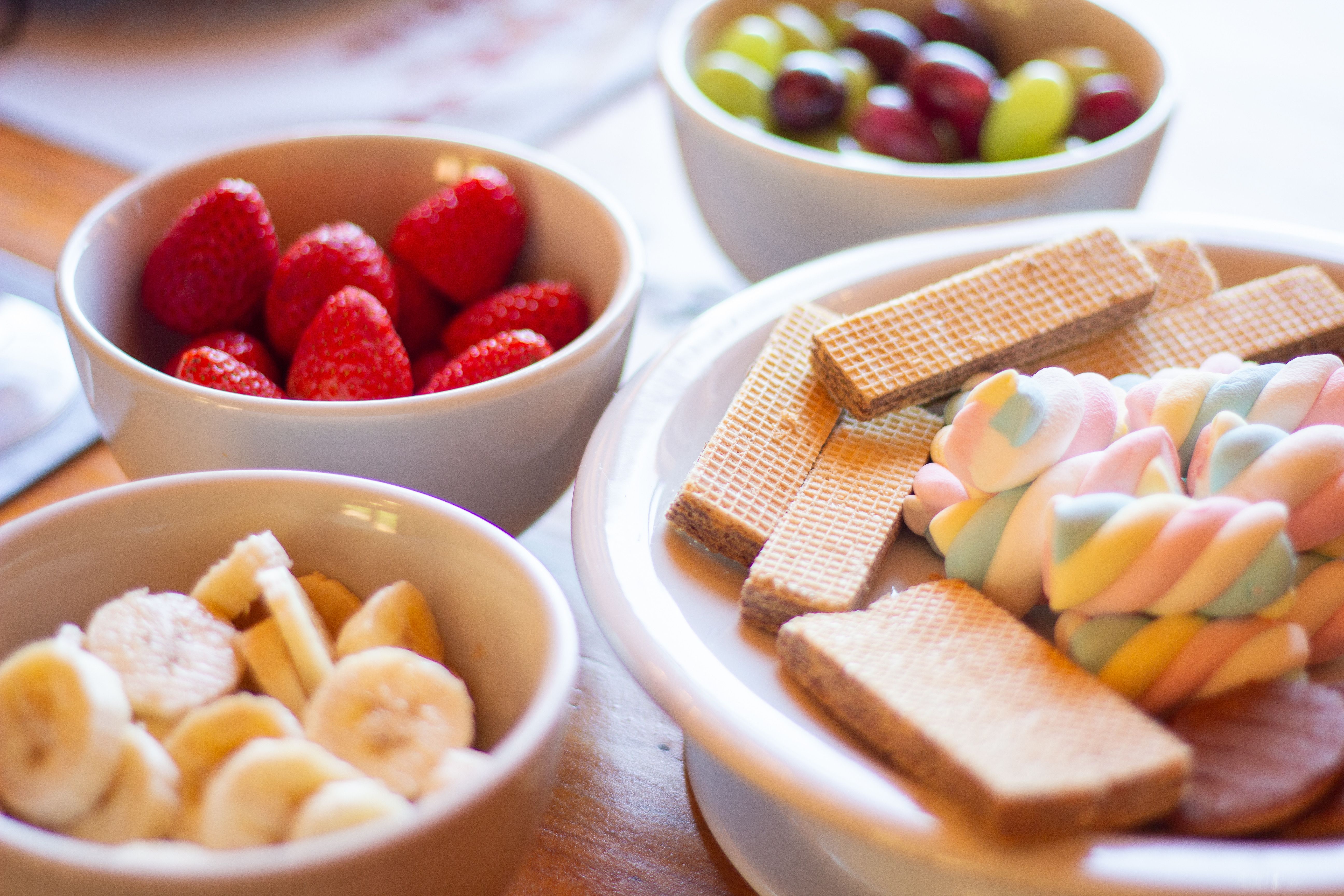 Assorted Sweet Snacks and Fruits in Bowls · Free Stock Photo