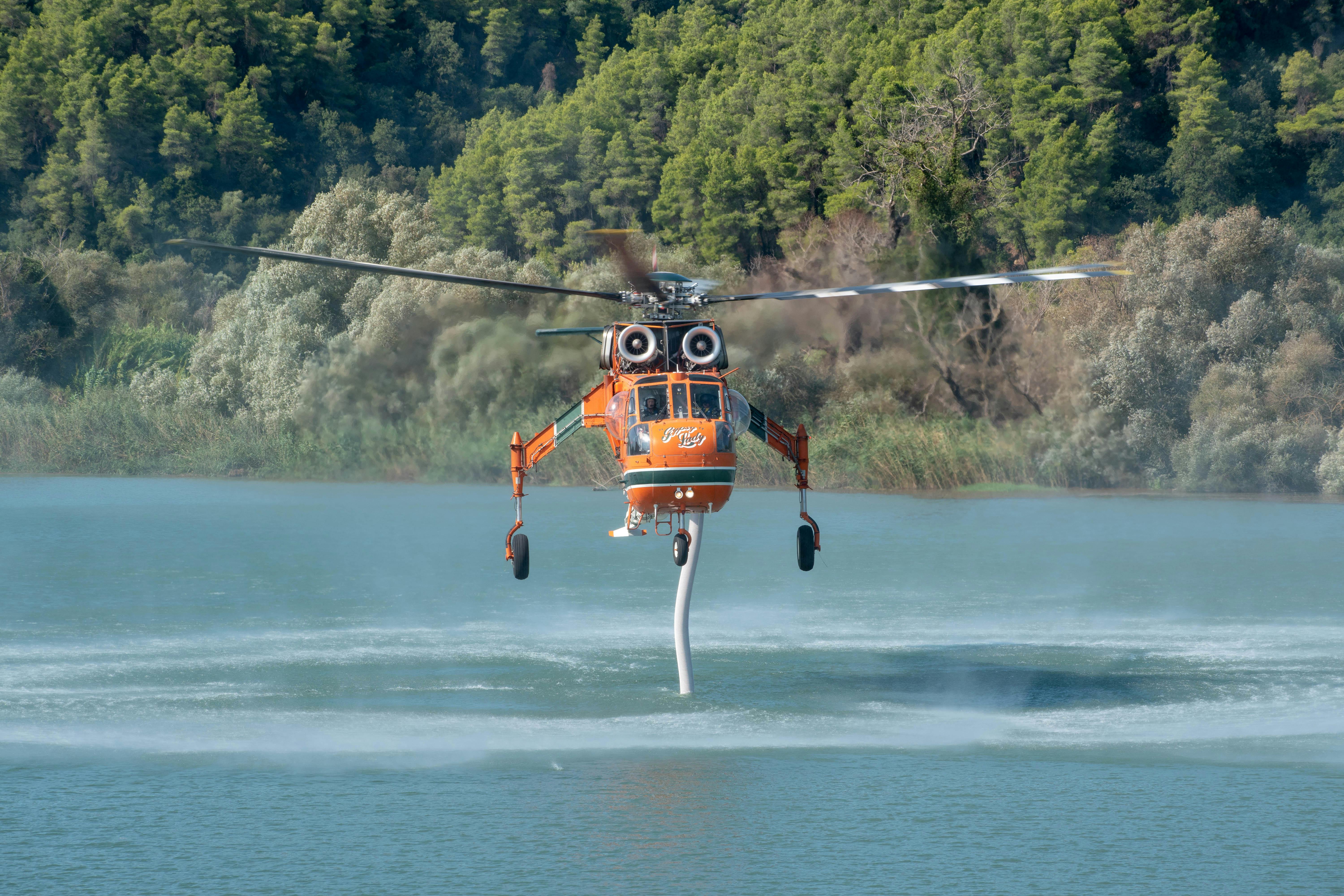 Aerial Firefighting Helicopter Over Greek River · Free Stock Photo