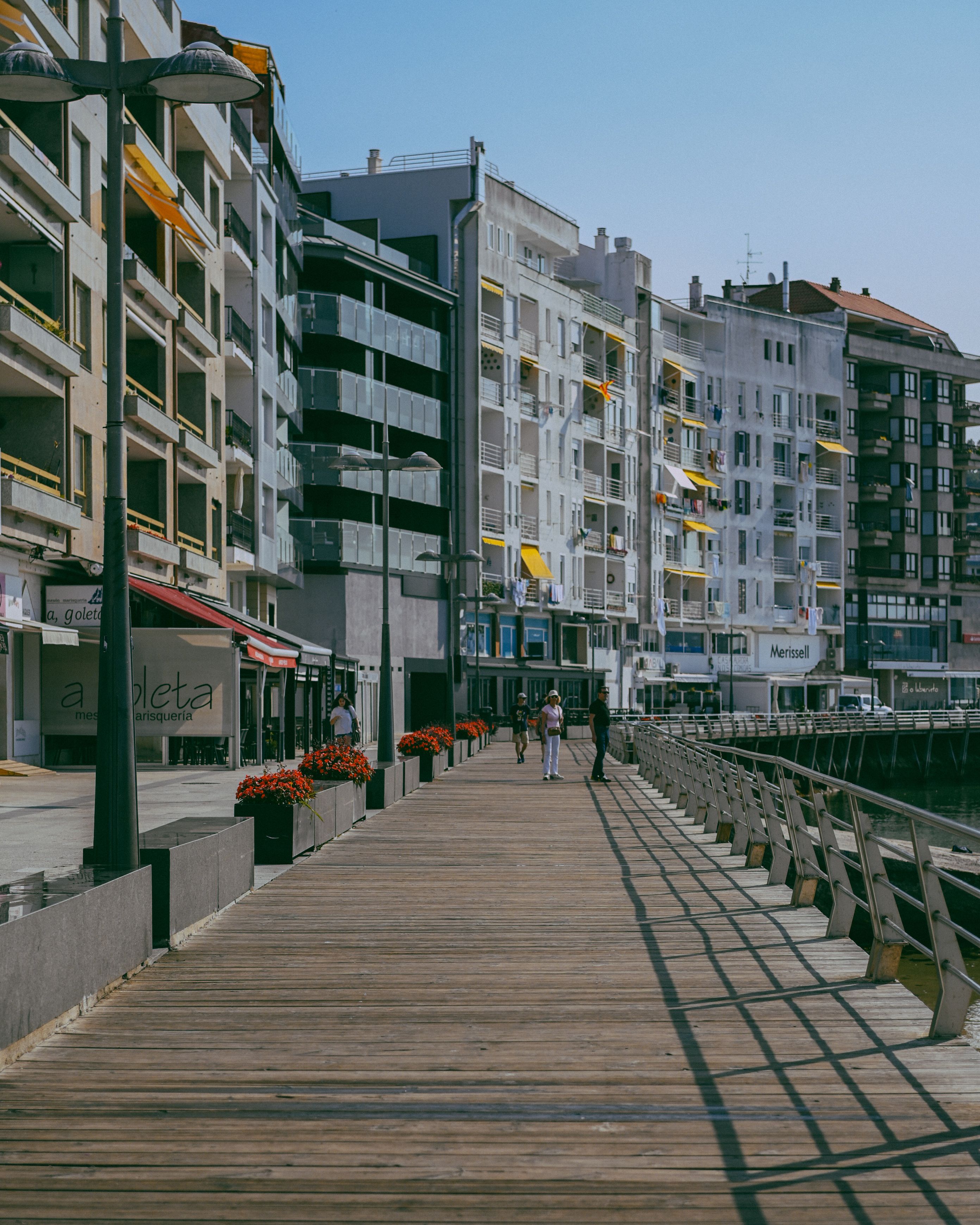 Scenic Coastal Boardwalk with Modern Apartments · Free Stock Photo