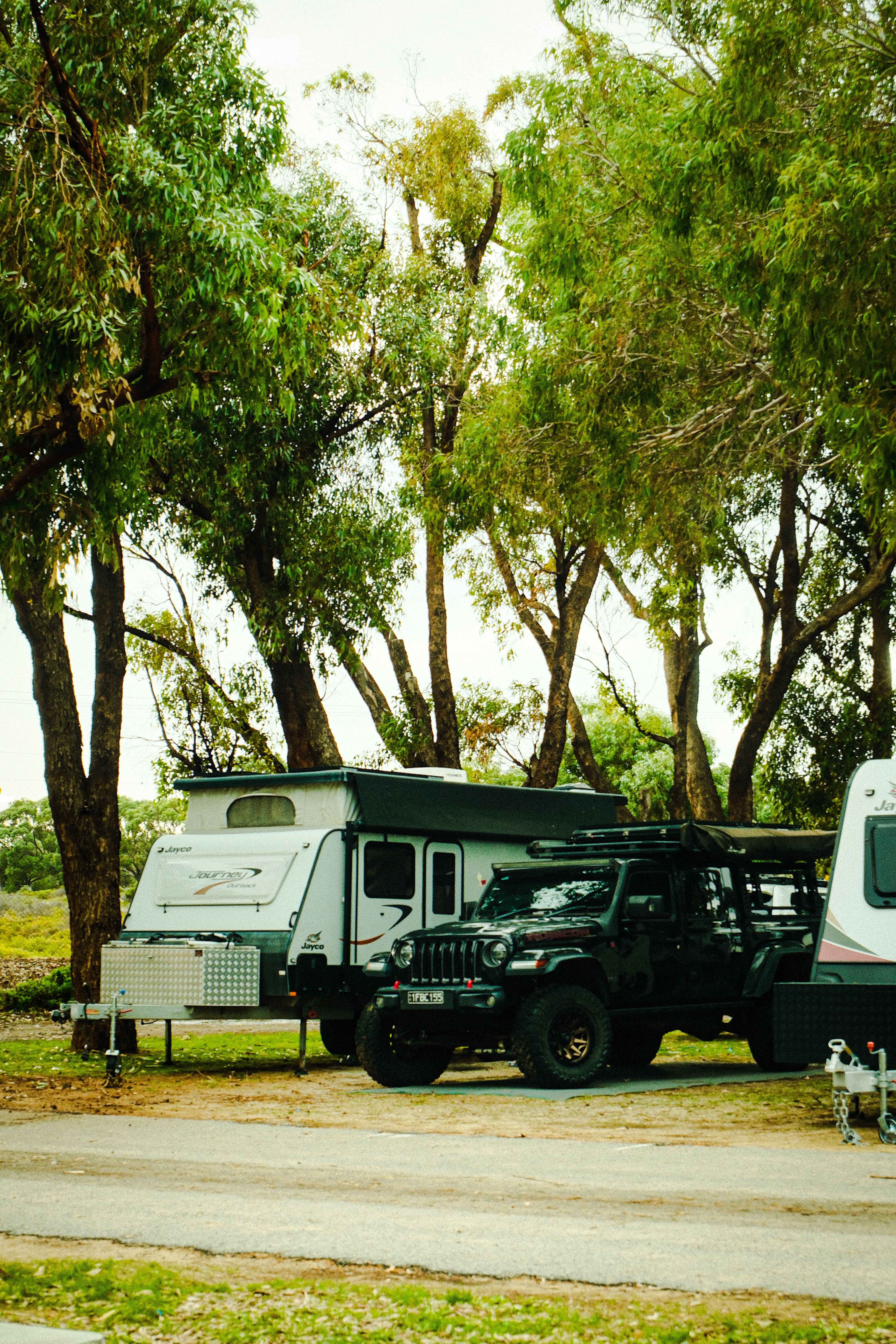 Off-road Camper and Jeep in Forest Setting · Free Stock Photo