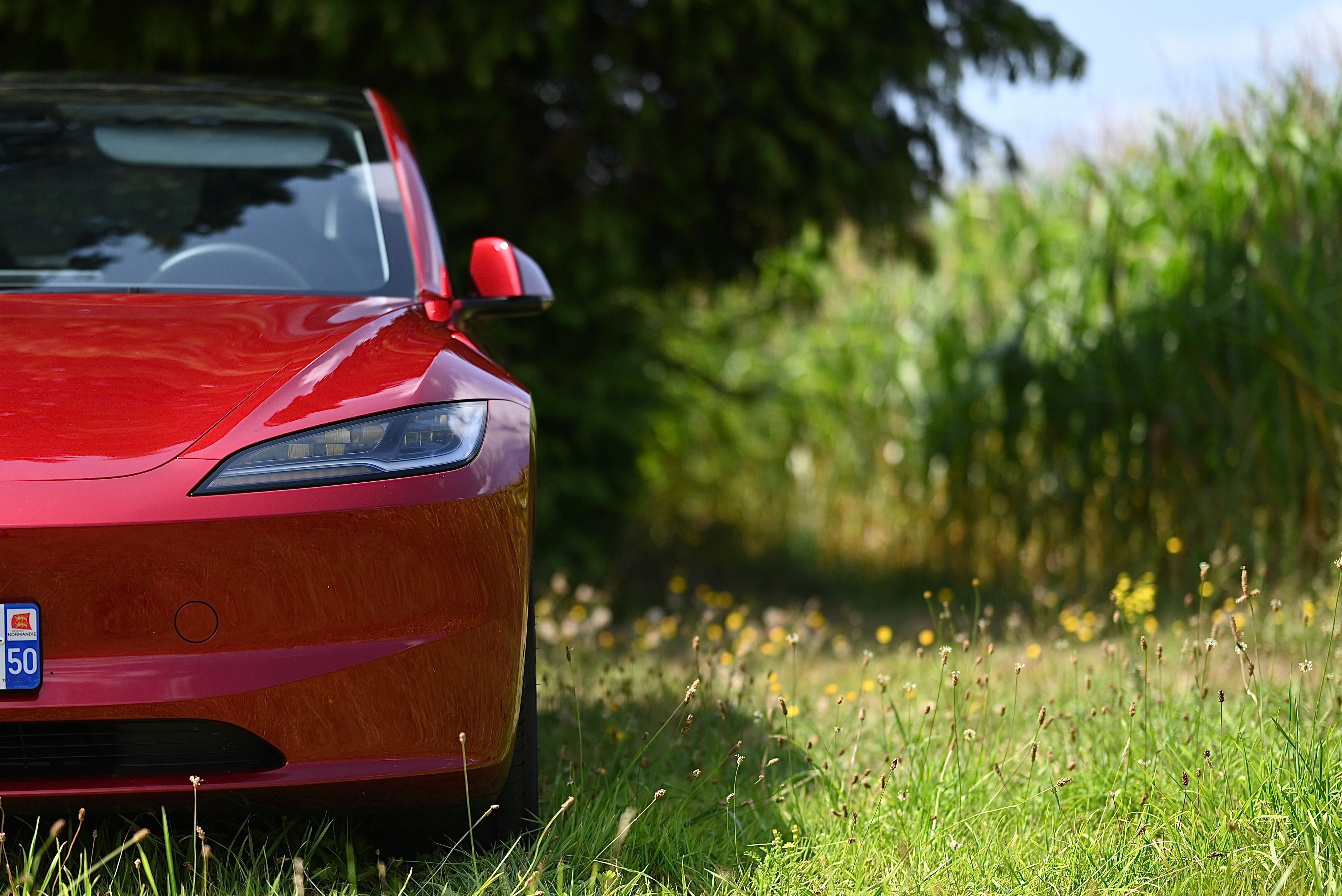Red Electric Car Parked in Sunny Countryside · Free Stock Photo