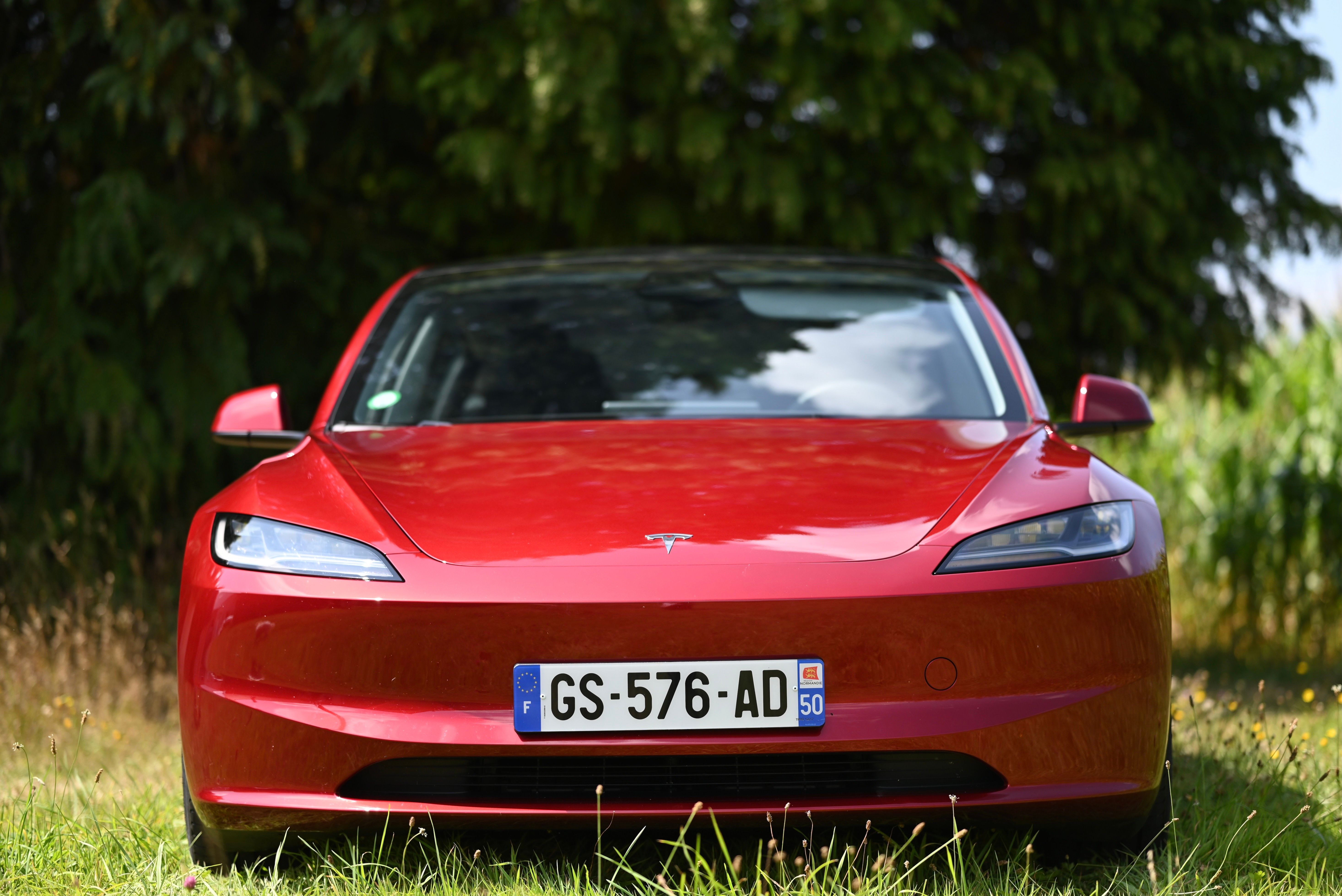 Red Electric Car Parked in Scenic Outdoor Setting · Free Stock Photo