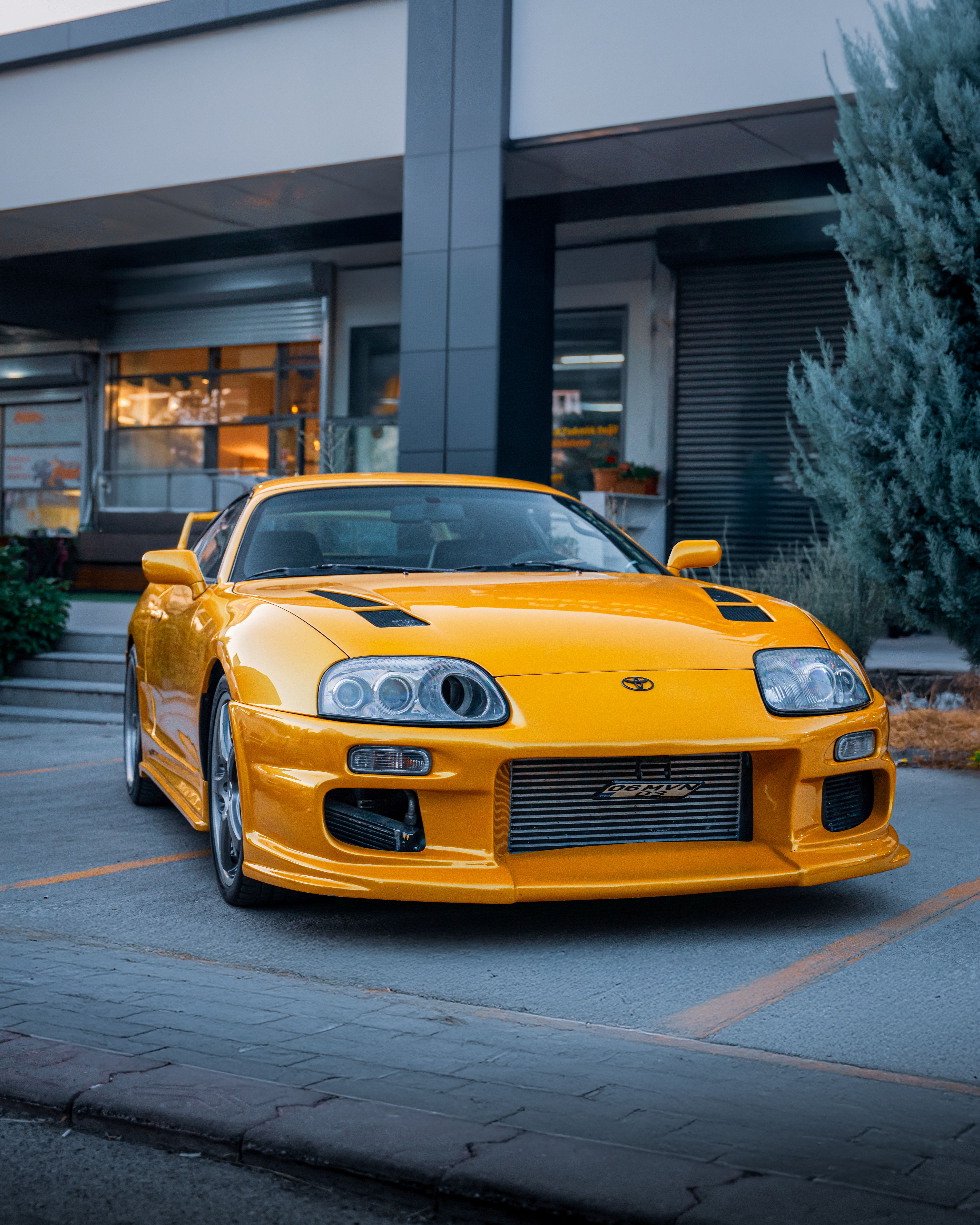 Vibrant Yellow Toyota Supra in Urban Setting · Free Stock Photo