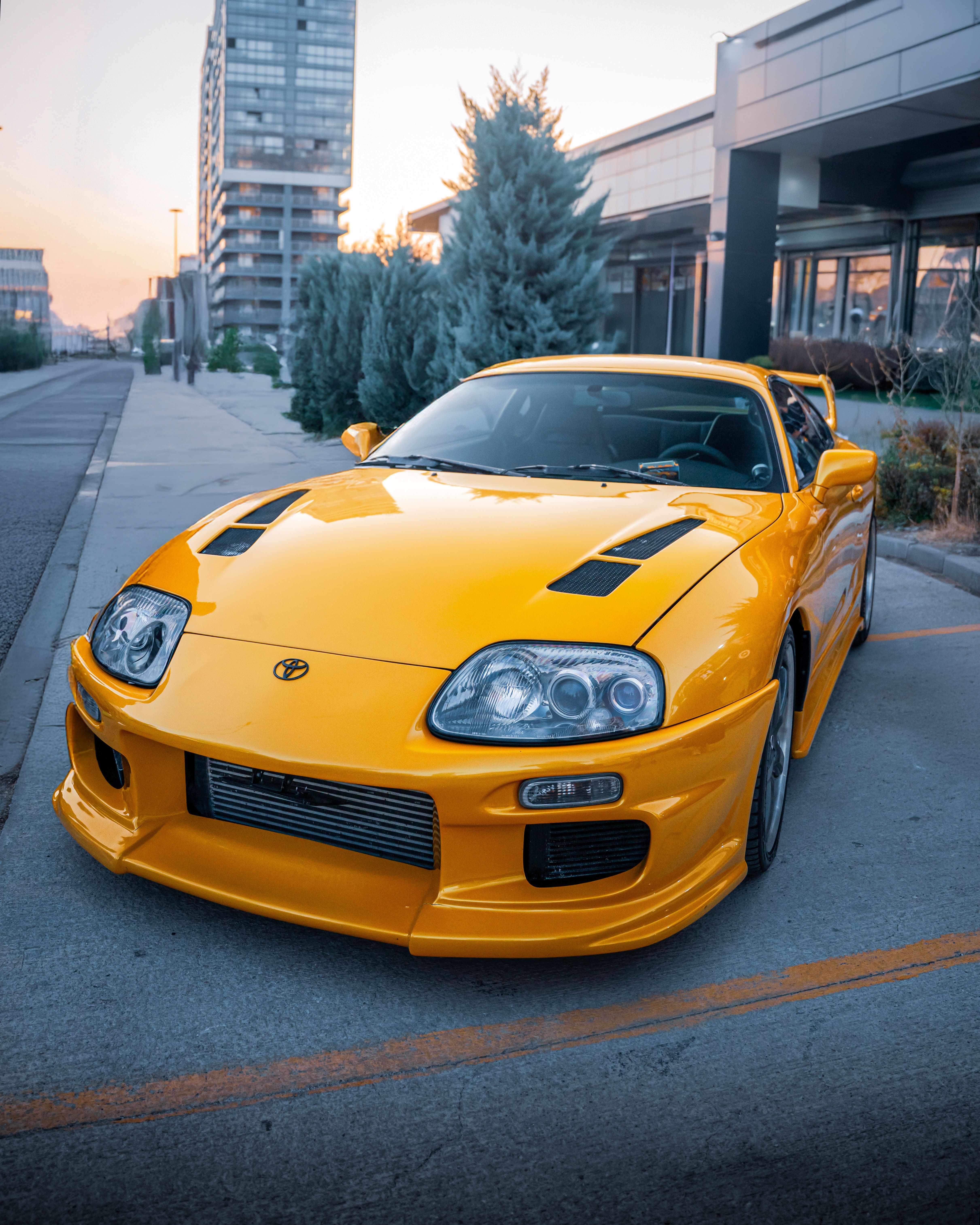Yellow Toyota Supra on City Street at Sunset · Free Stock Photo