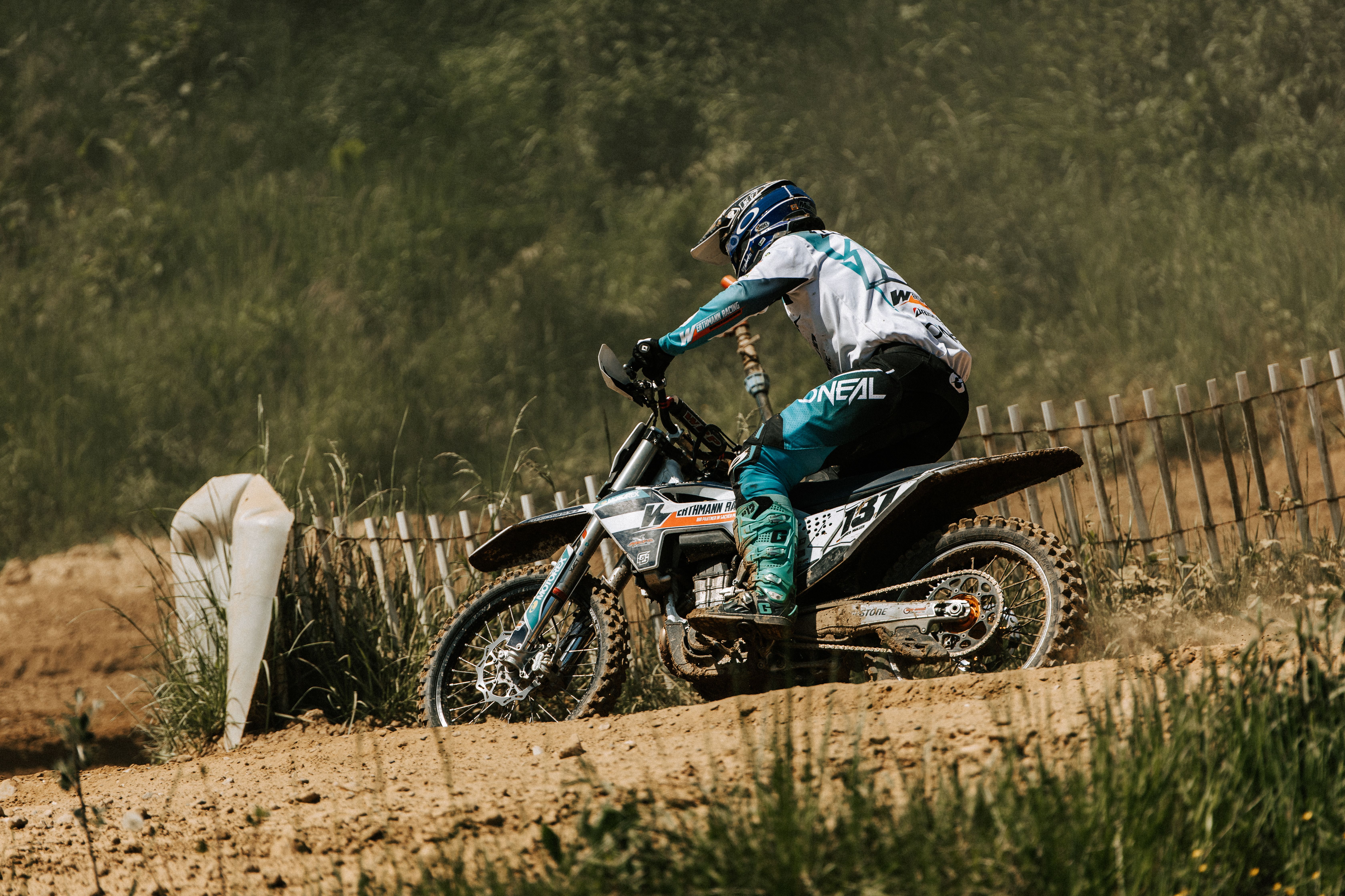 Motocross Racer in Action on Dirt Track · Free Stock Photo