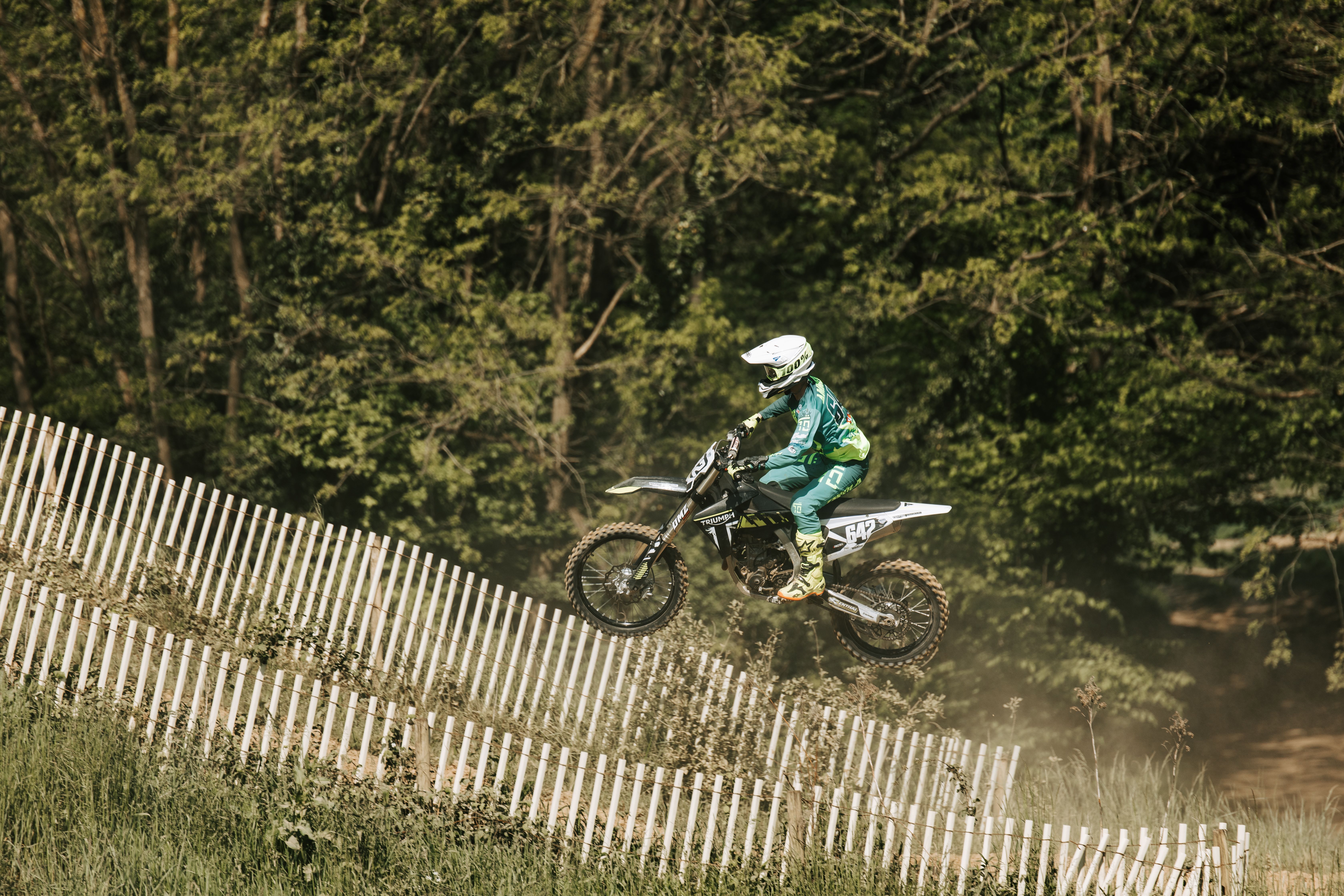 Dynamic Motocross Rider in Action on Dirt Track · Free Stock Photo