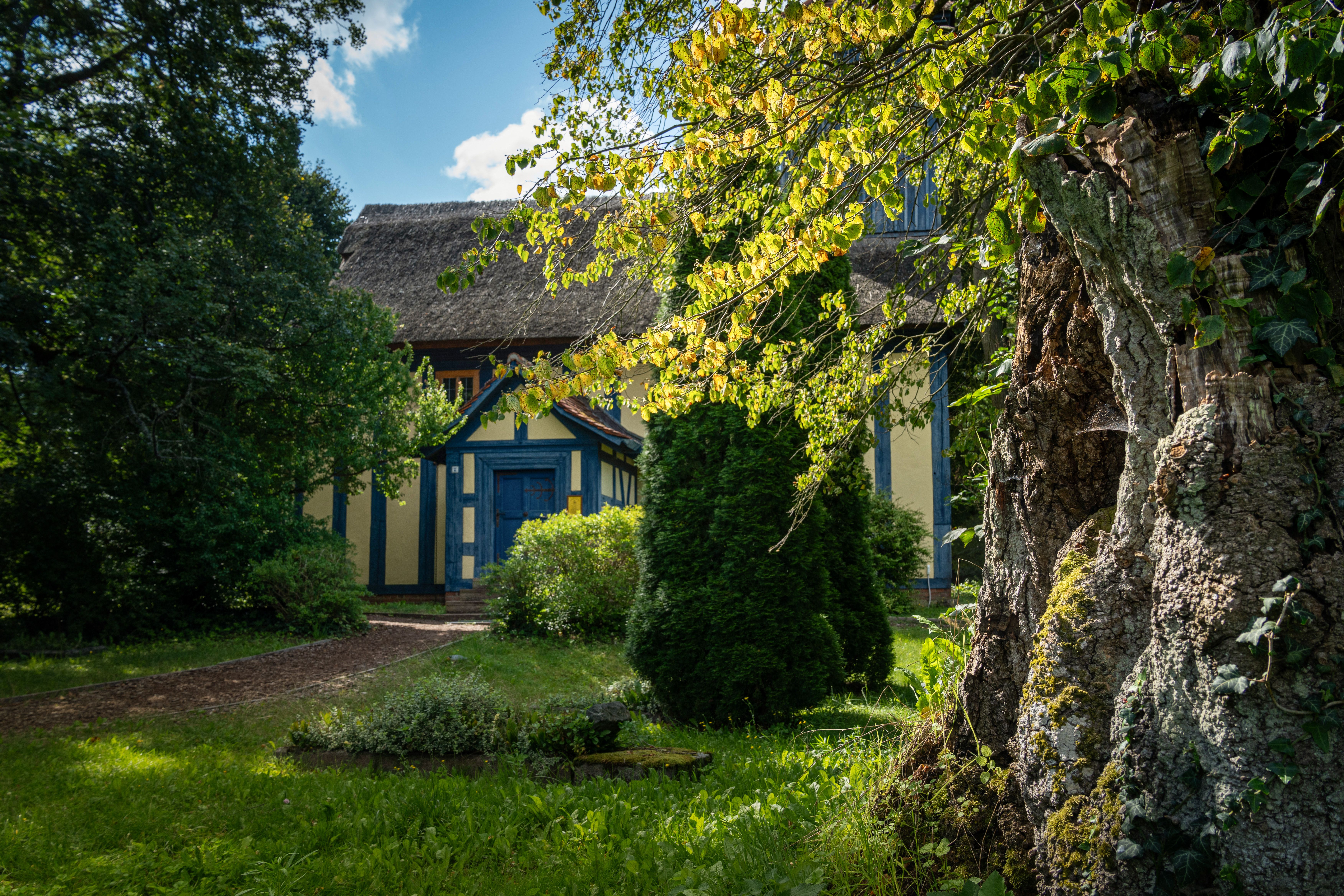 Charming Rustic Chapel in a Lush Summer Landscape · Free Stock Photo