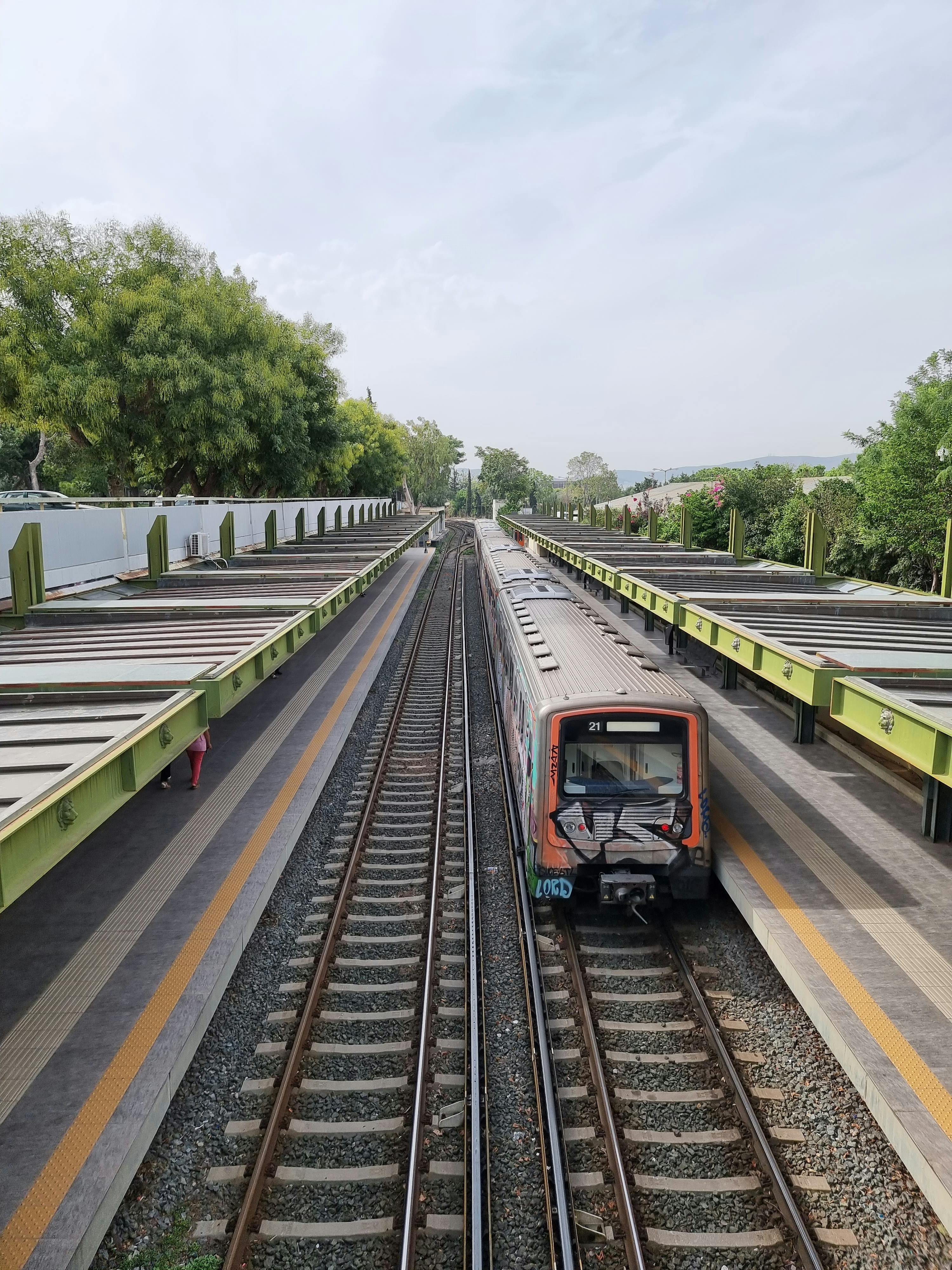 Symmetrical Train Tracks in Outdoor Greek Station · Free Stock Photo