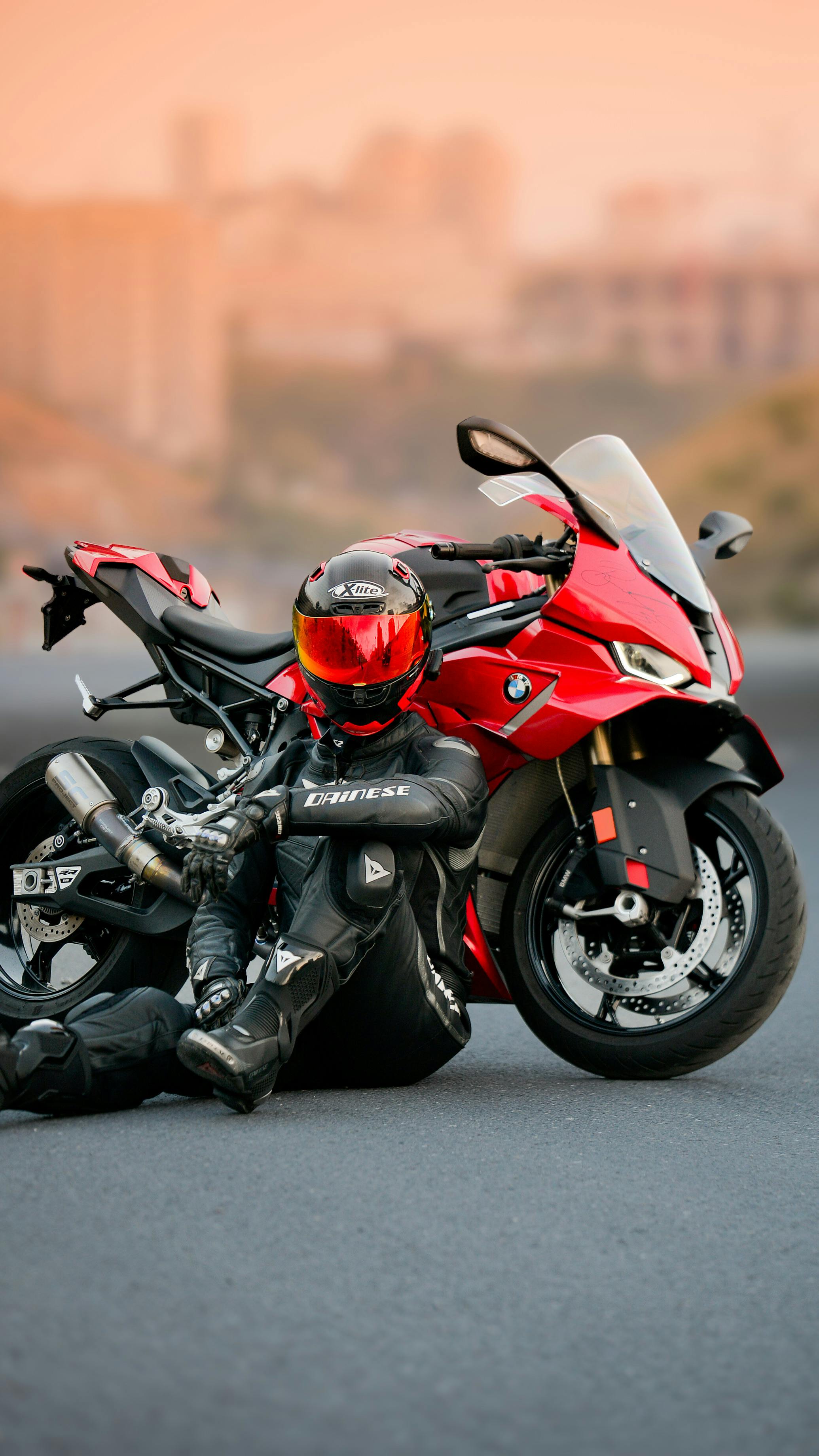 Motorcyclist Relaxing Next to Sporty Red Motorcycle · Free Stock Photo