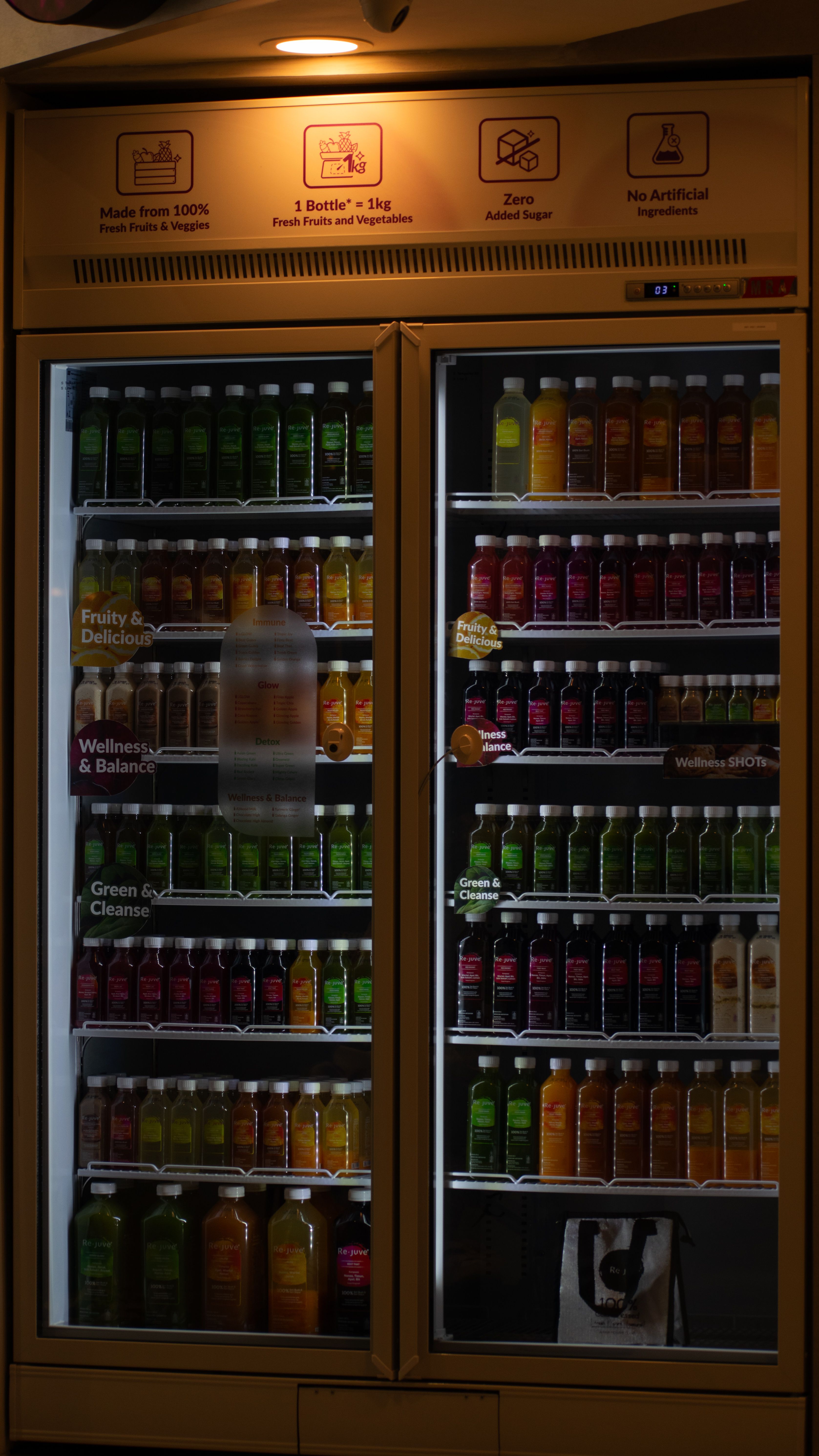 Refrigerated Display of Colorful Juice Bottles · Free Stock Photo